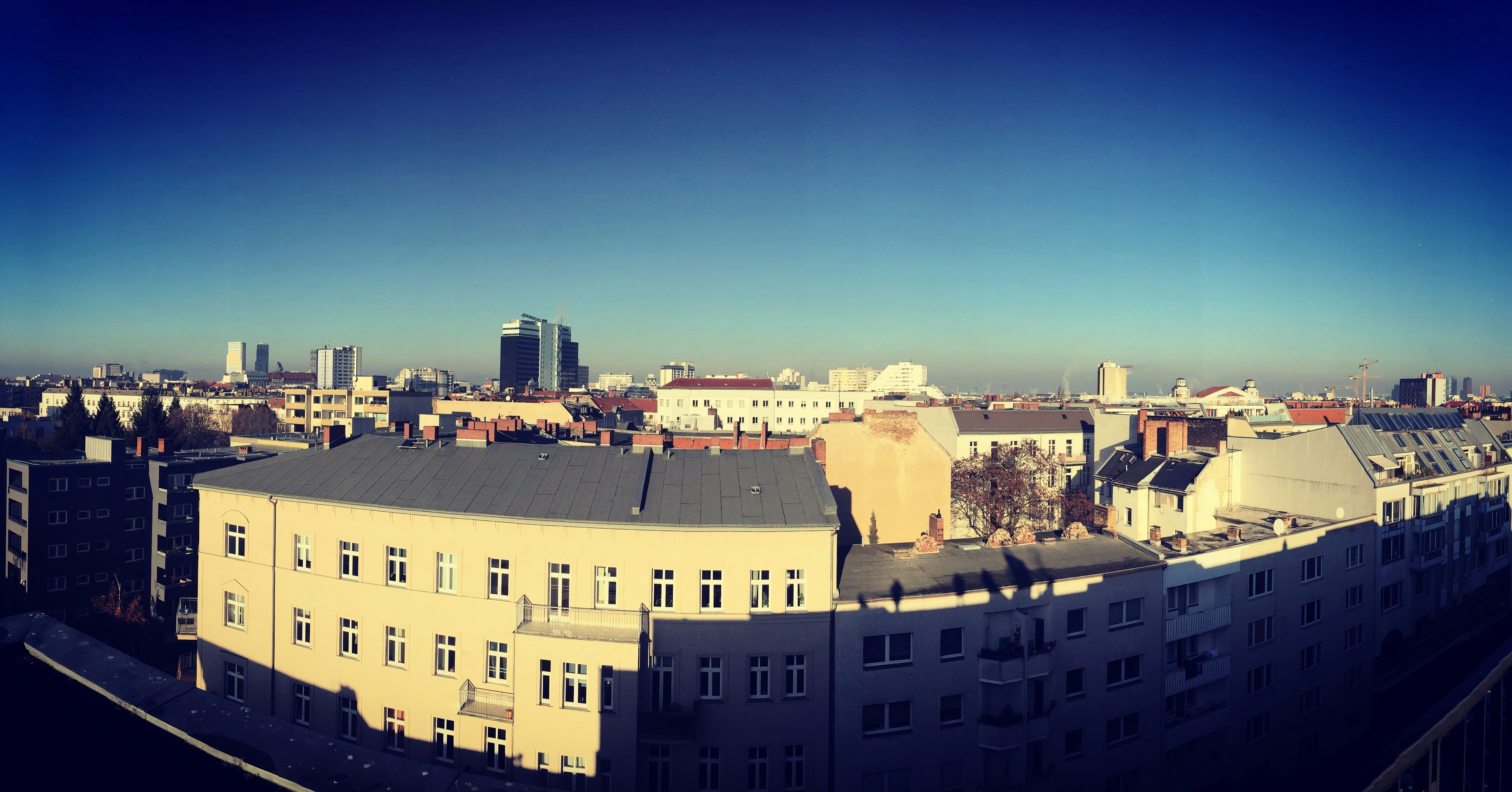 Sunlit Low-Angle Cityscape Over Pale, Gabled Complexity