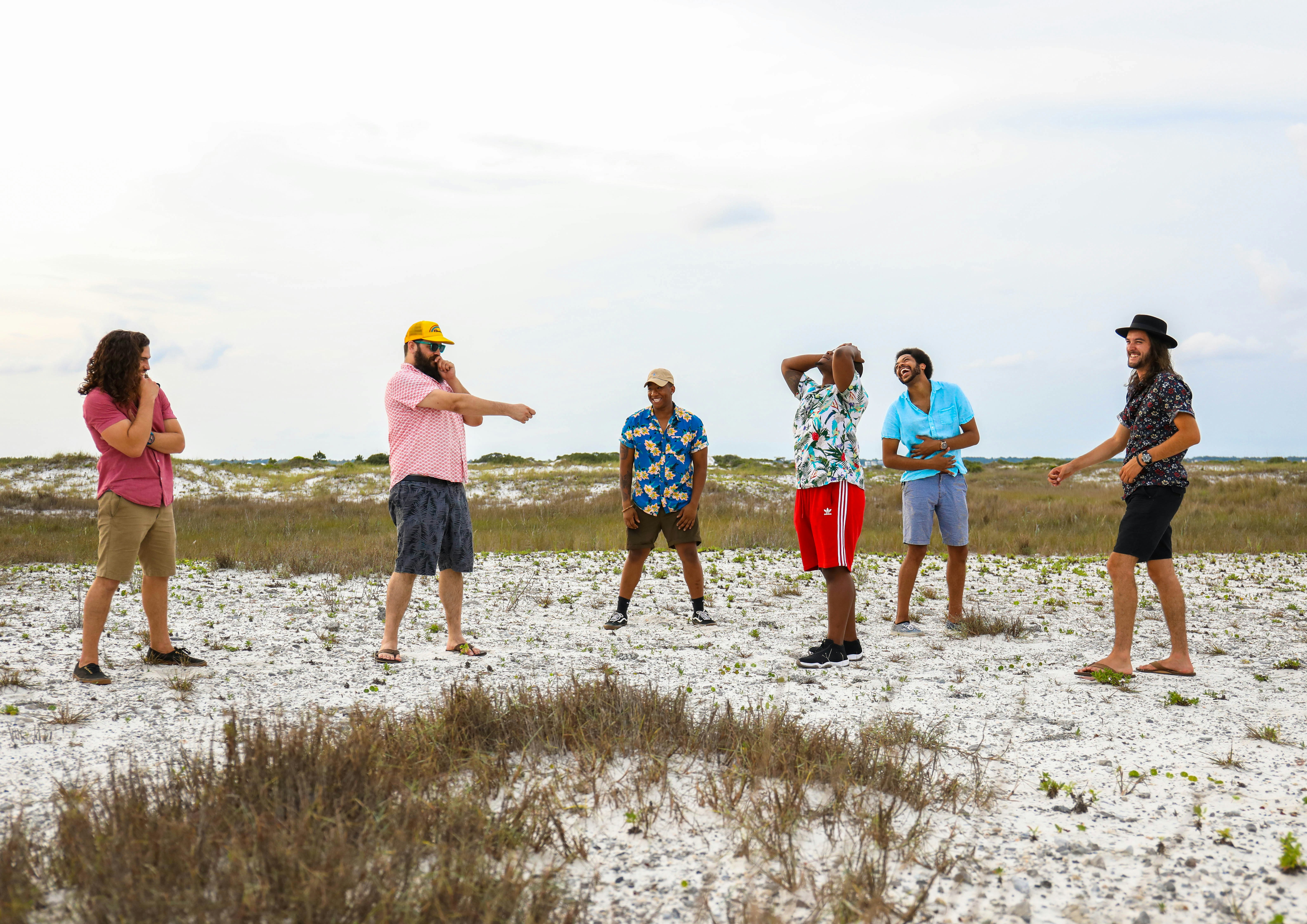 Pointing Across the Salt Flat: A Casual Group Portrait Under a Wide Sky