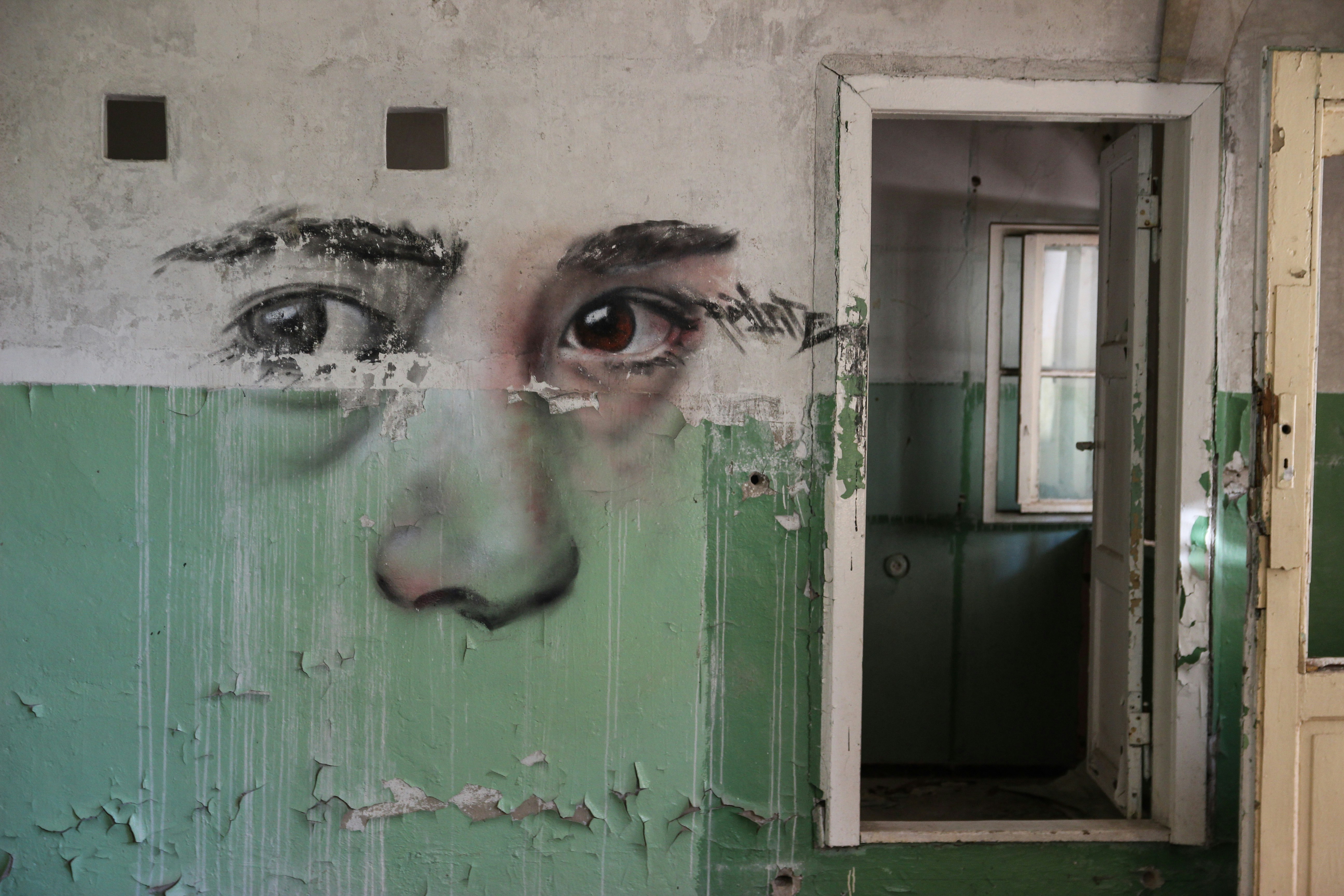 Eyes on a Silent Corridor: A Muralscape in Decay