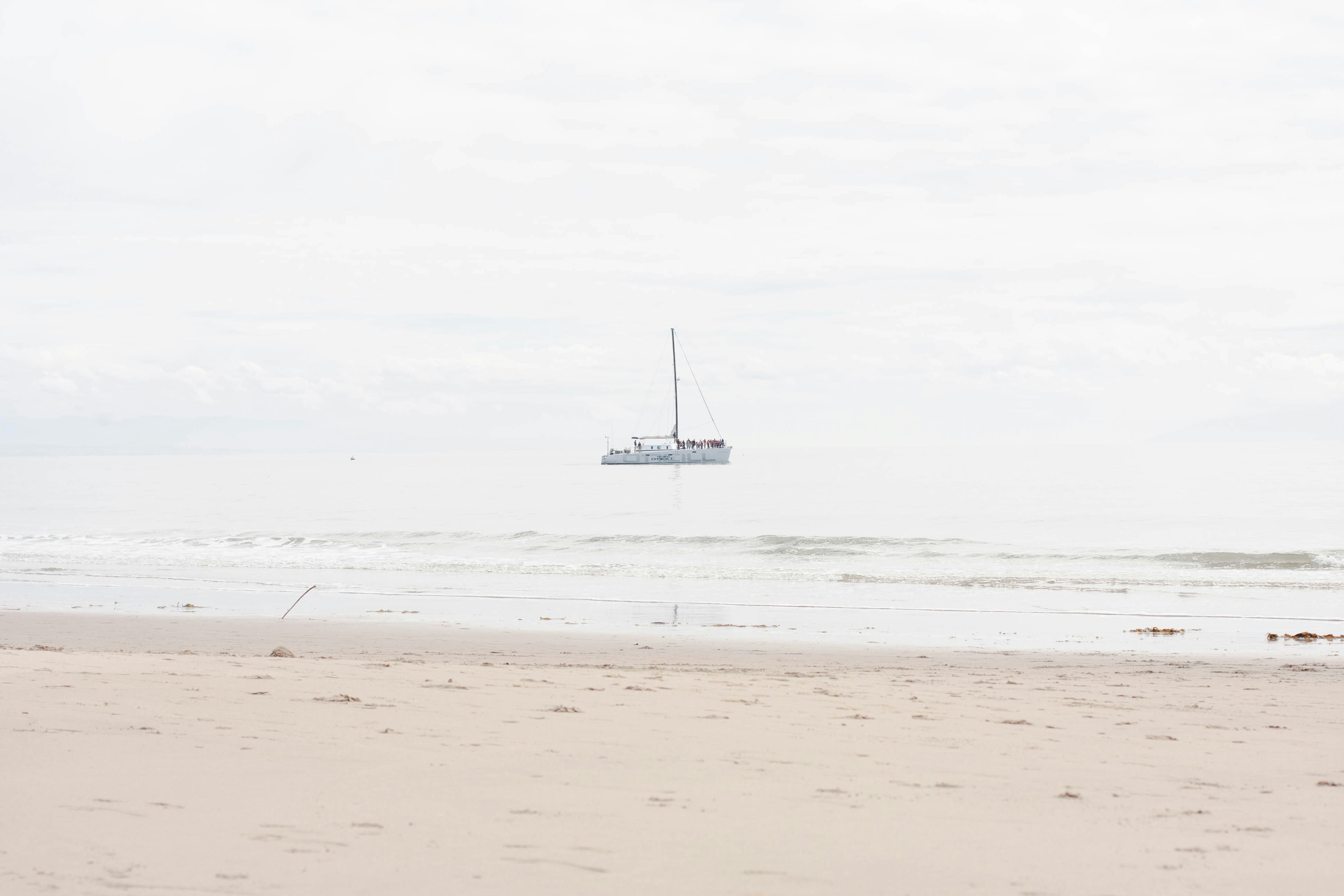 Solitary Sail on a Misty Dune