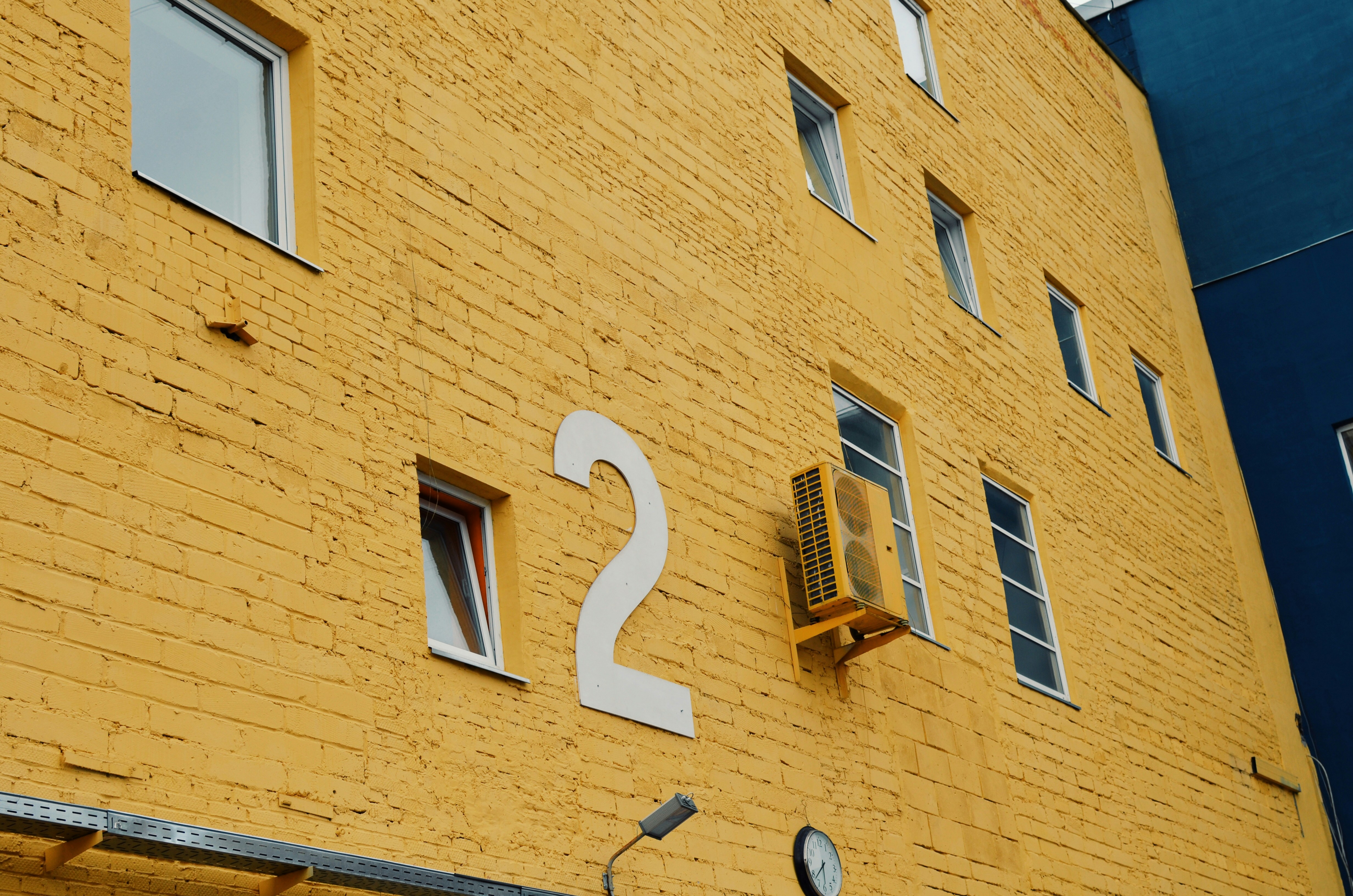Number Two on a Sunlit Yellow Facade