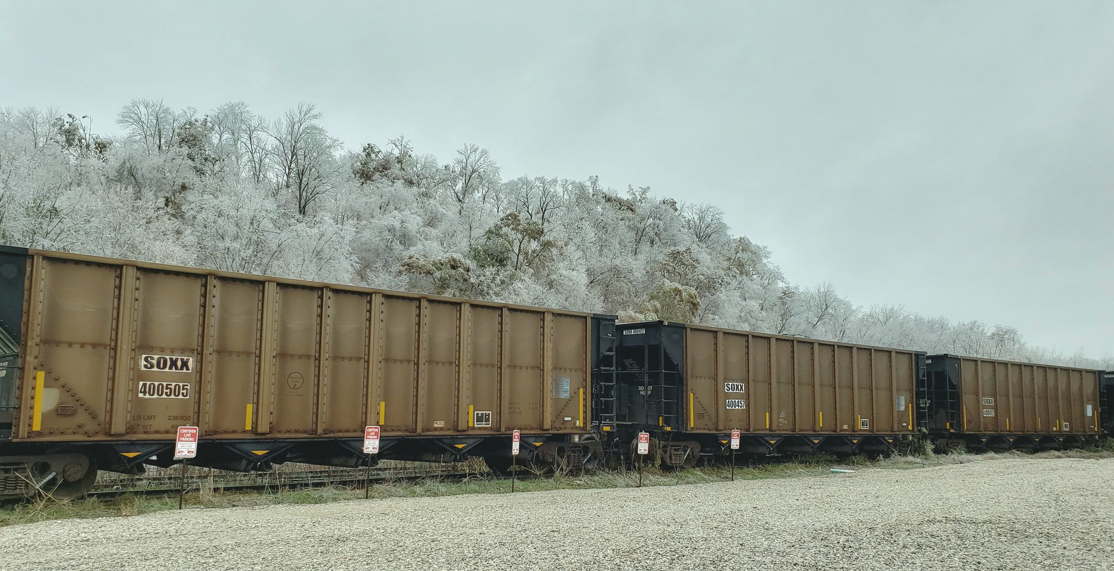Hardened Rails at Dawn: A Long Row of Freight Cars on a Gravel Yard