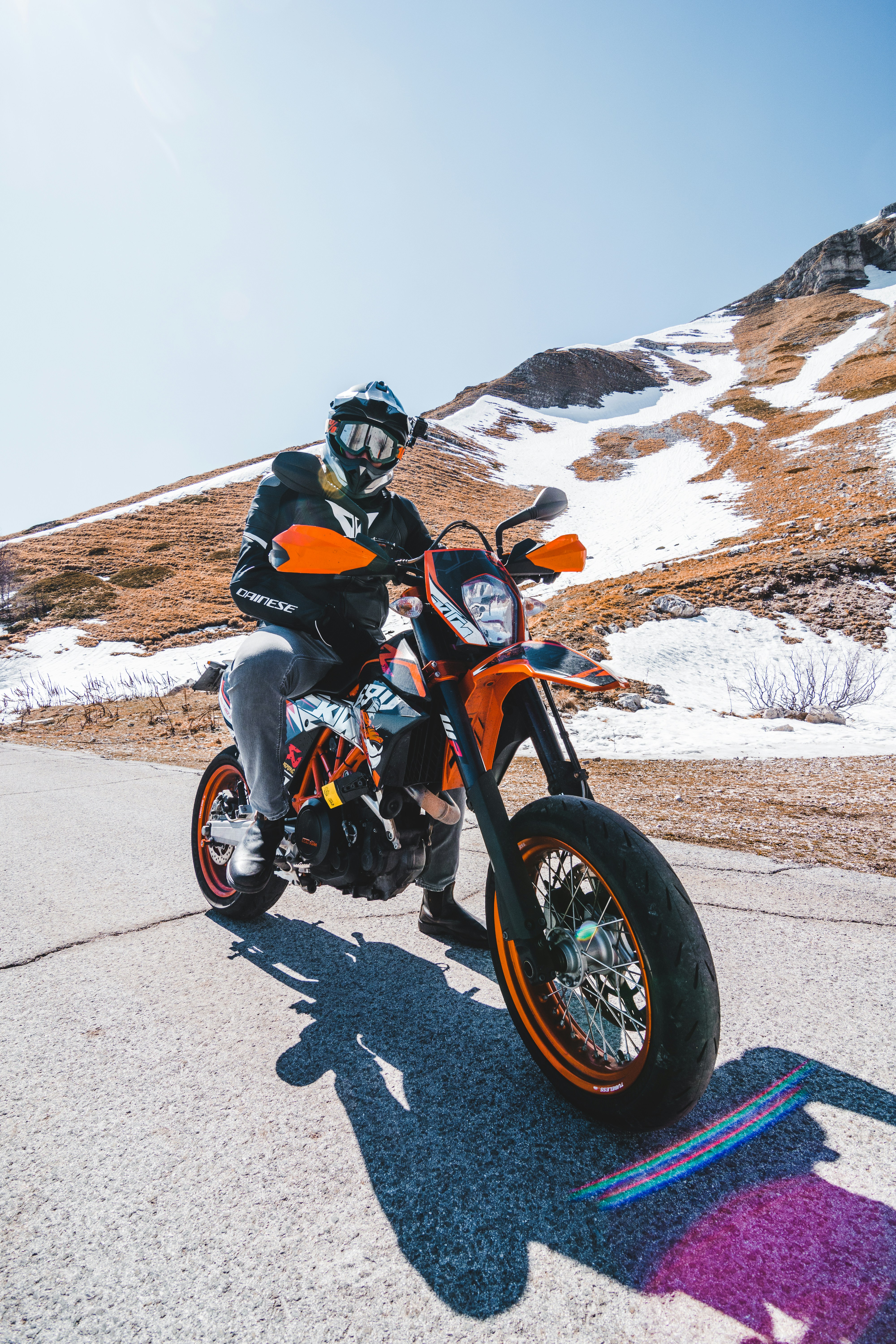 Orange KTM on a Snow-Kissed Alpine Pass