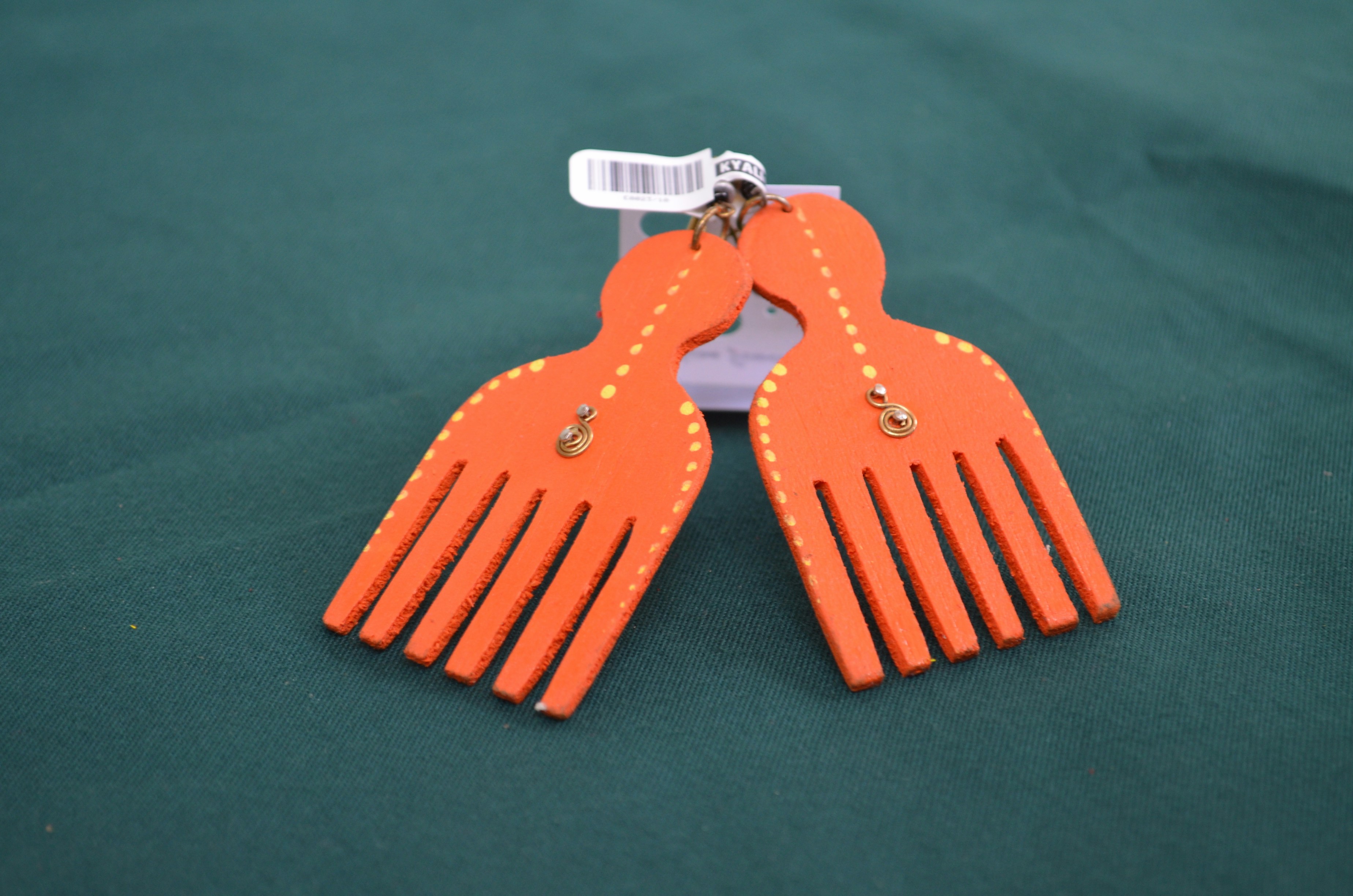 Twin Orange Fins Resting on Teal Fabric: A Minimal Dive Gear Still Life