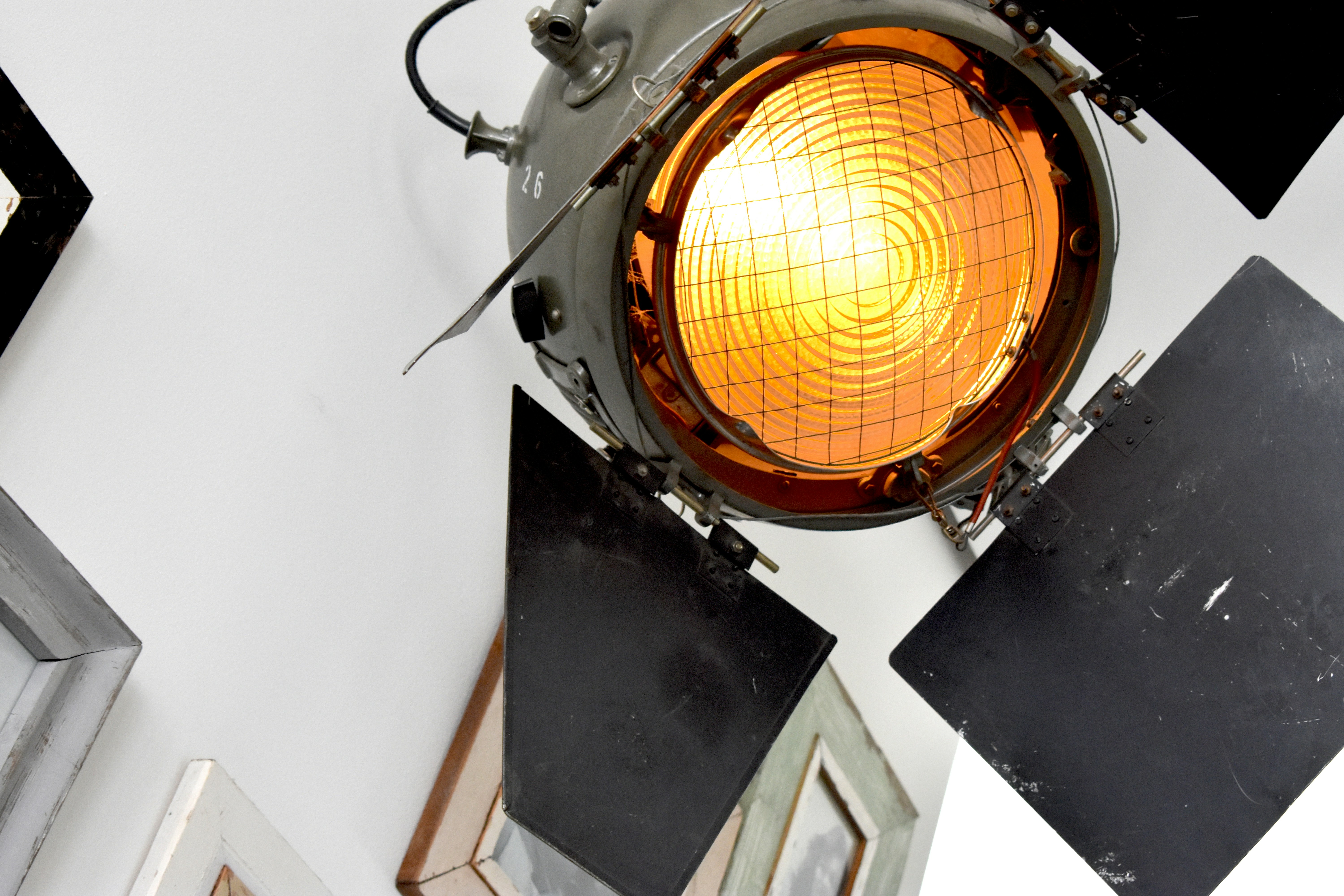 Fiery Stage Eye: Close-Up of an Orange Spotlight Framed by Angular Black Panels
