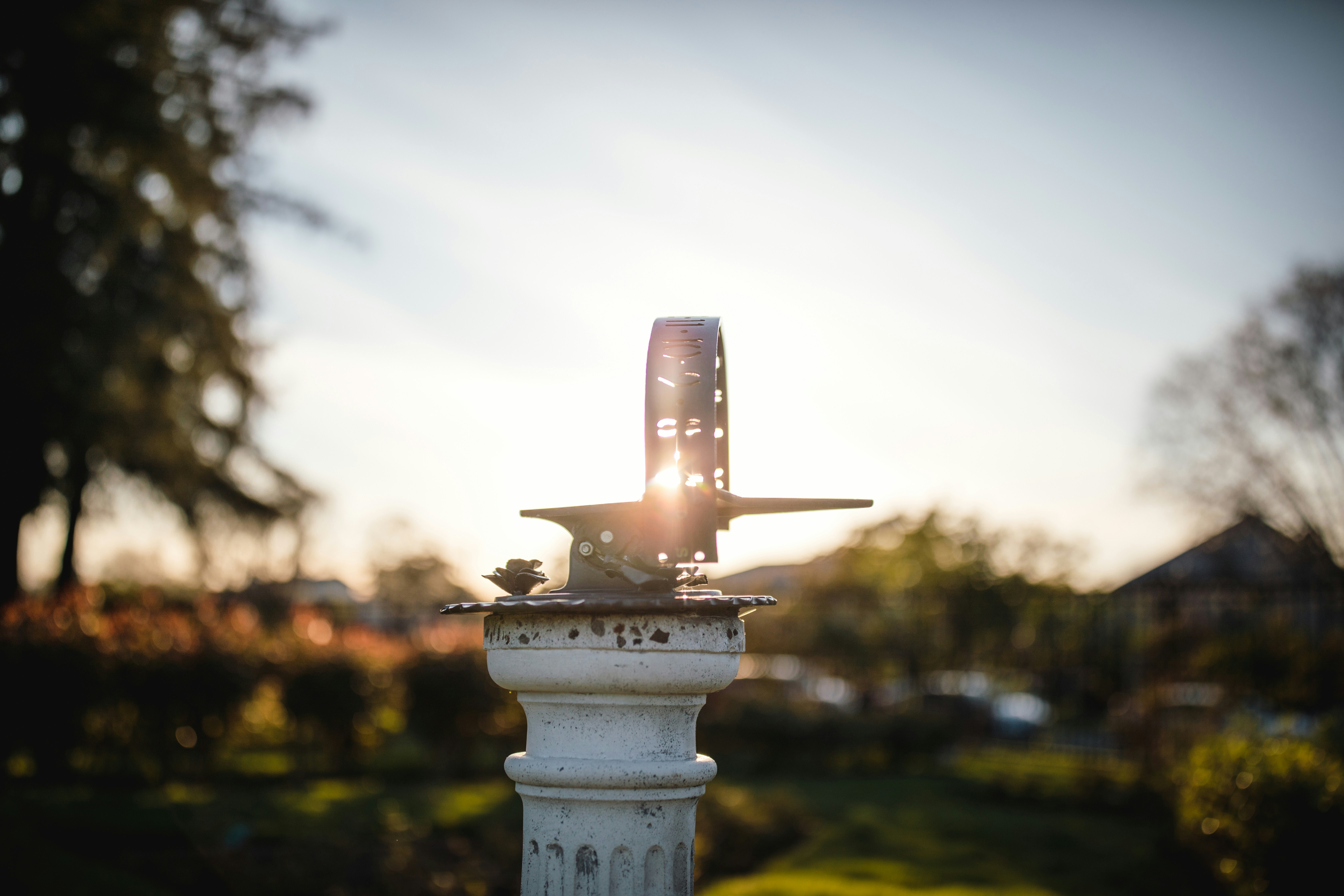 Sunlit Pour: A Vintage Pedestal Finial Catching the Last Light