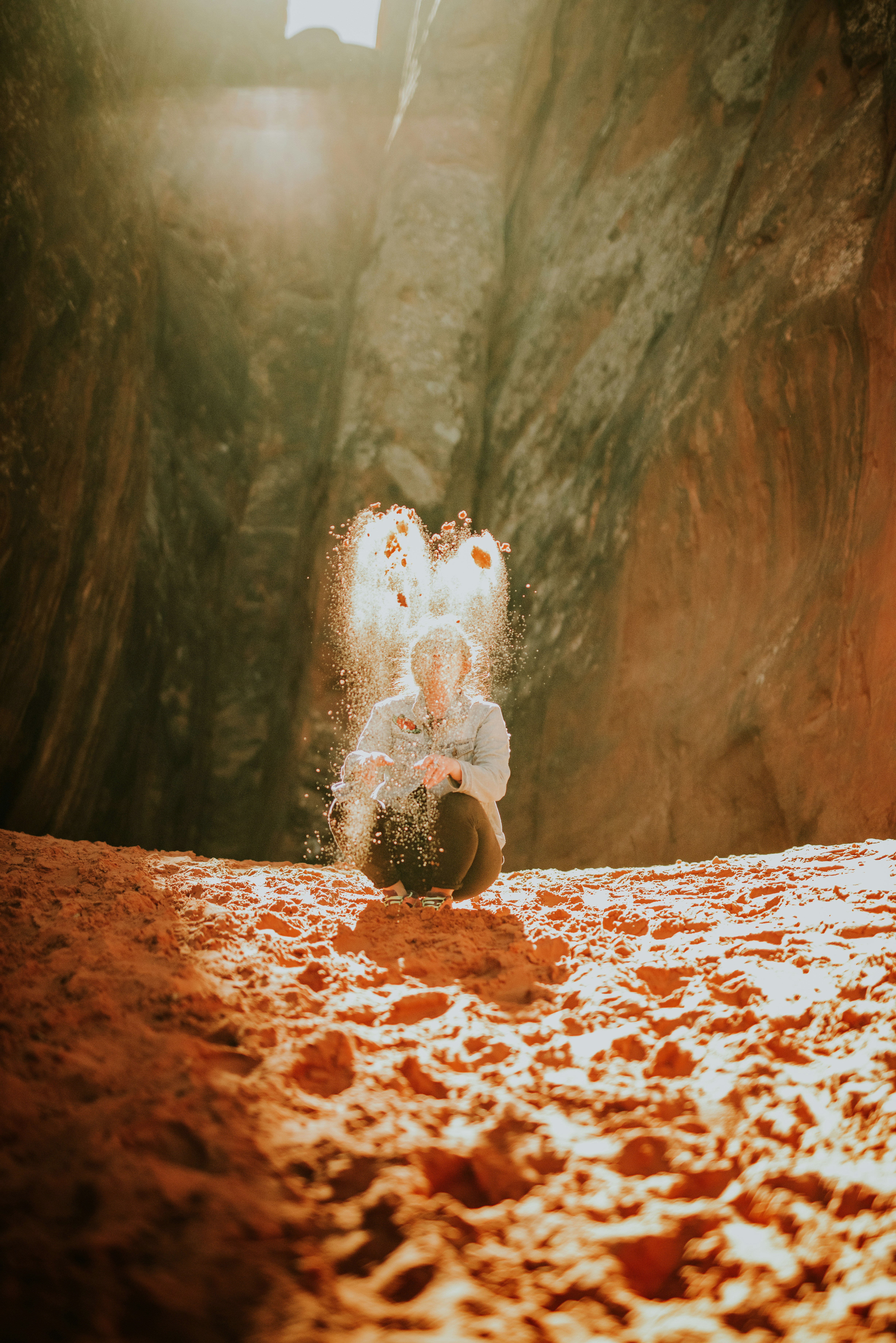 Man sitting beside brown rocky mountain photo – Free Nature Image on ...
