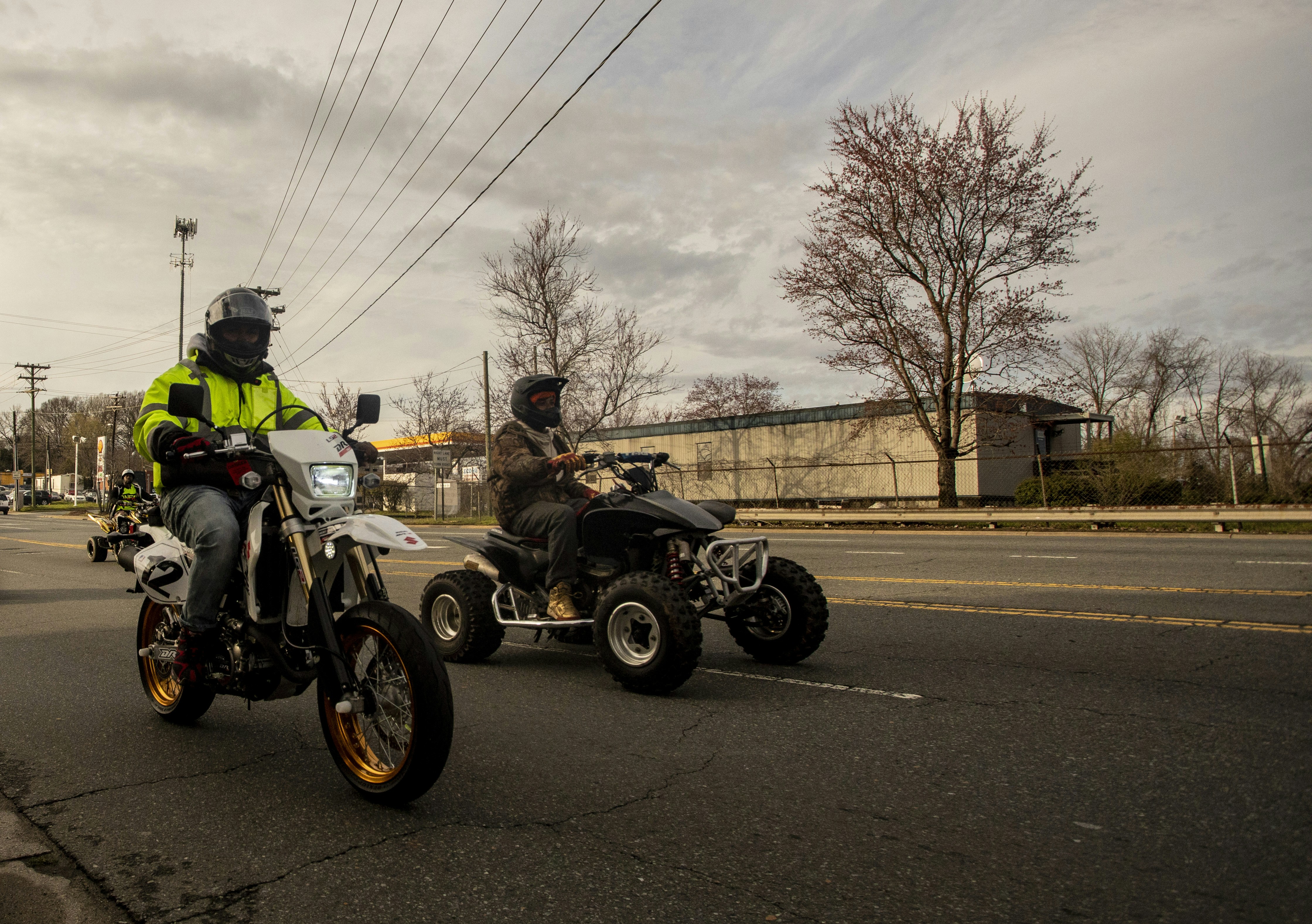Neon-Clad Rider Leads the Street-Side Moto Parade