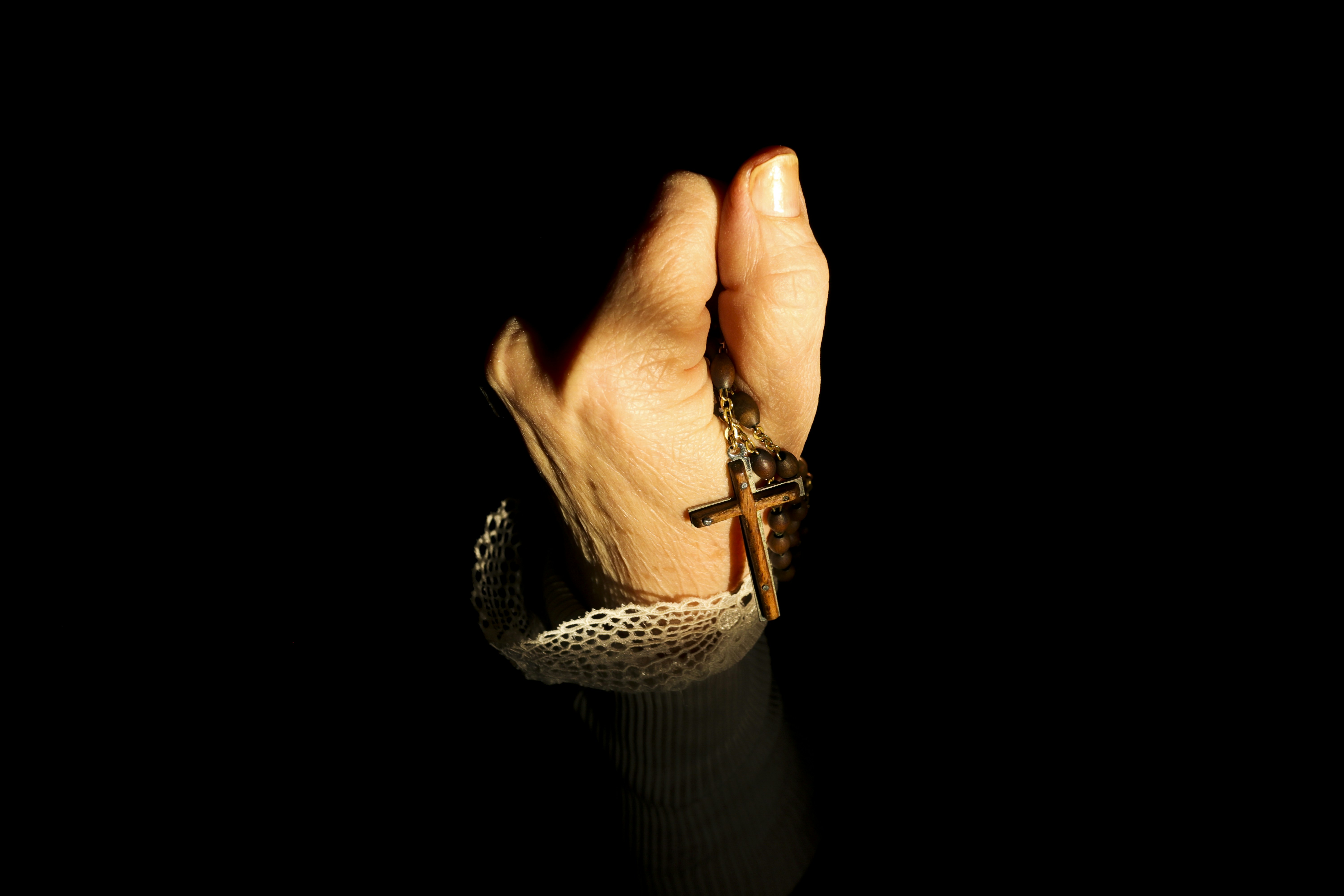 Person grasping cross photo – Free Brown Image on Unsplash