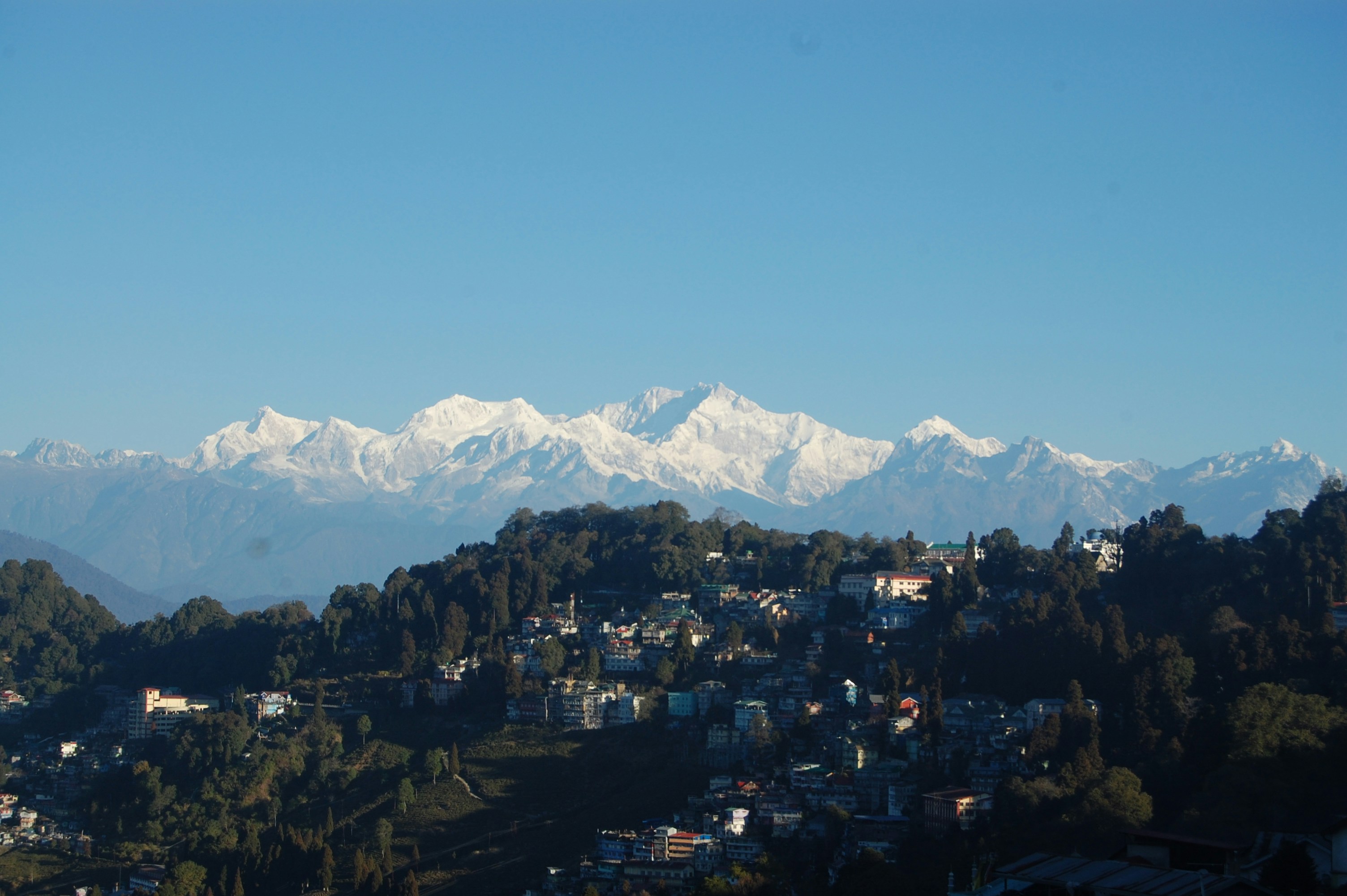 Snow-Capped Summit Over a Tranquil Hillside Village