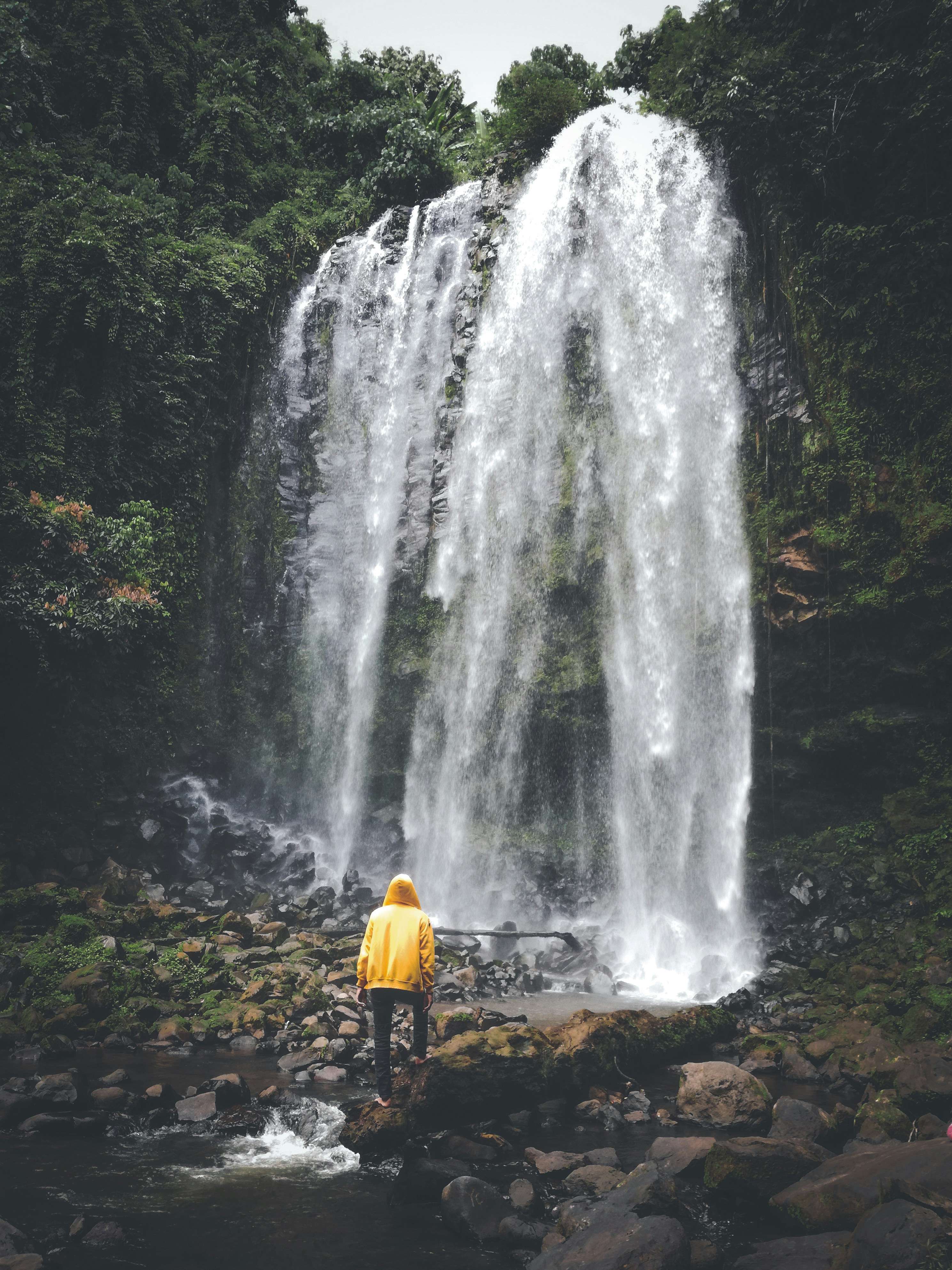 Person facing waterfalls photo – Free Grey Image on Unsplash