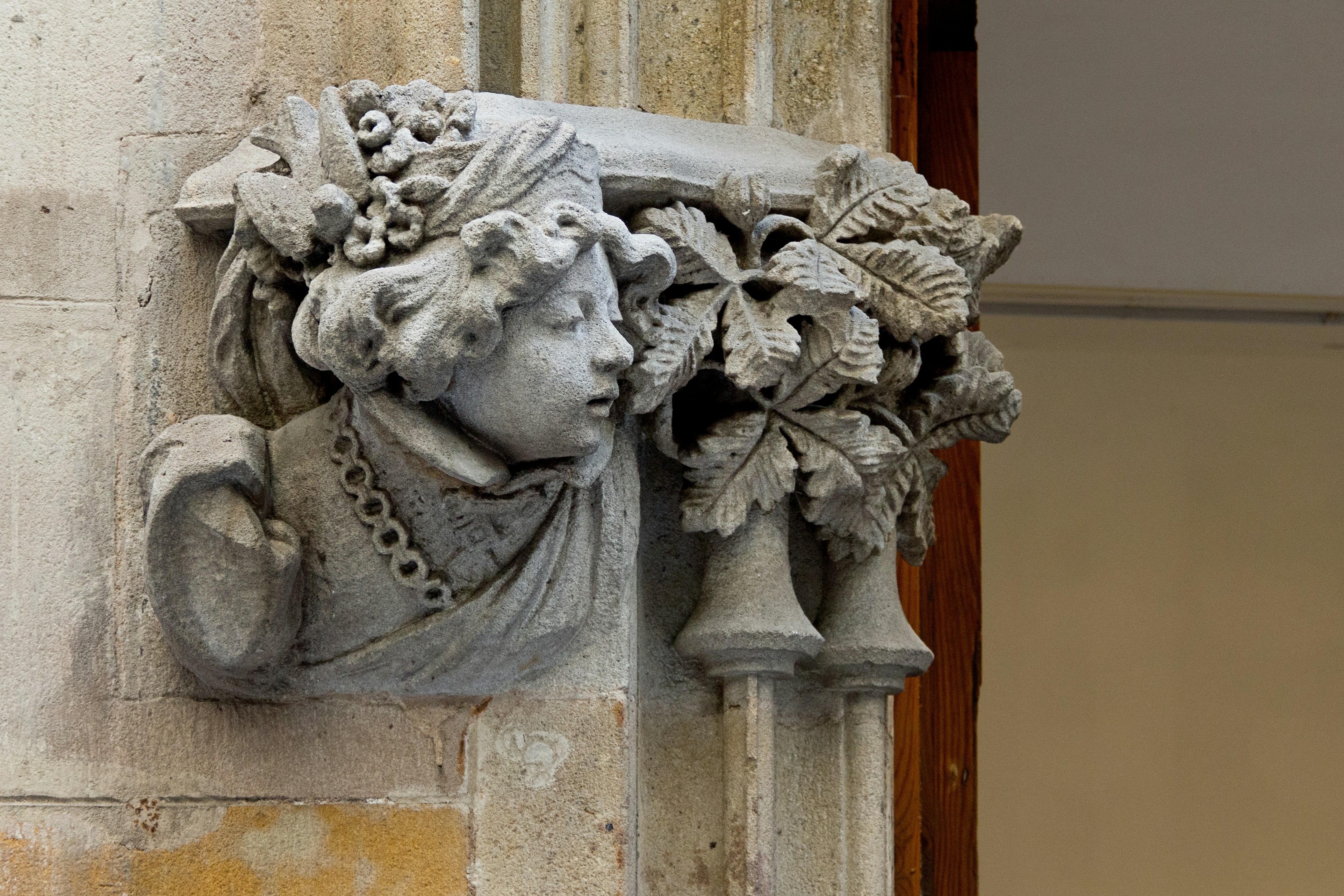 Stone Sentinel: a carved bust peers from a Gothic capital