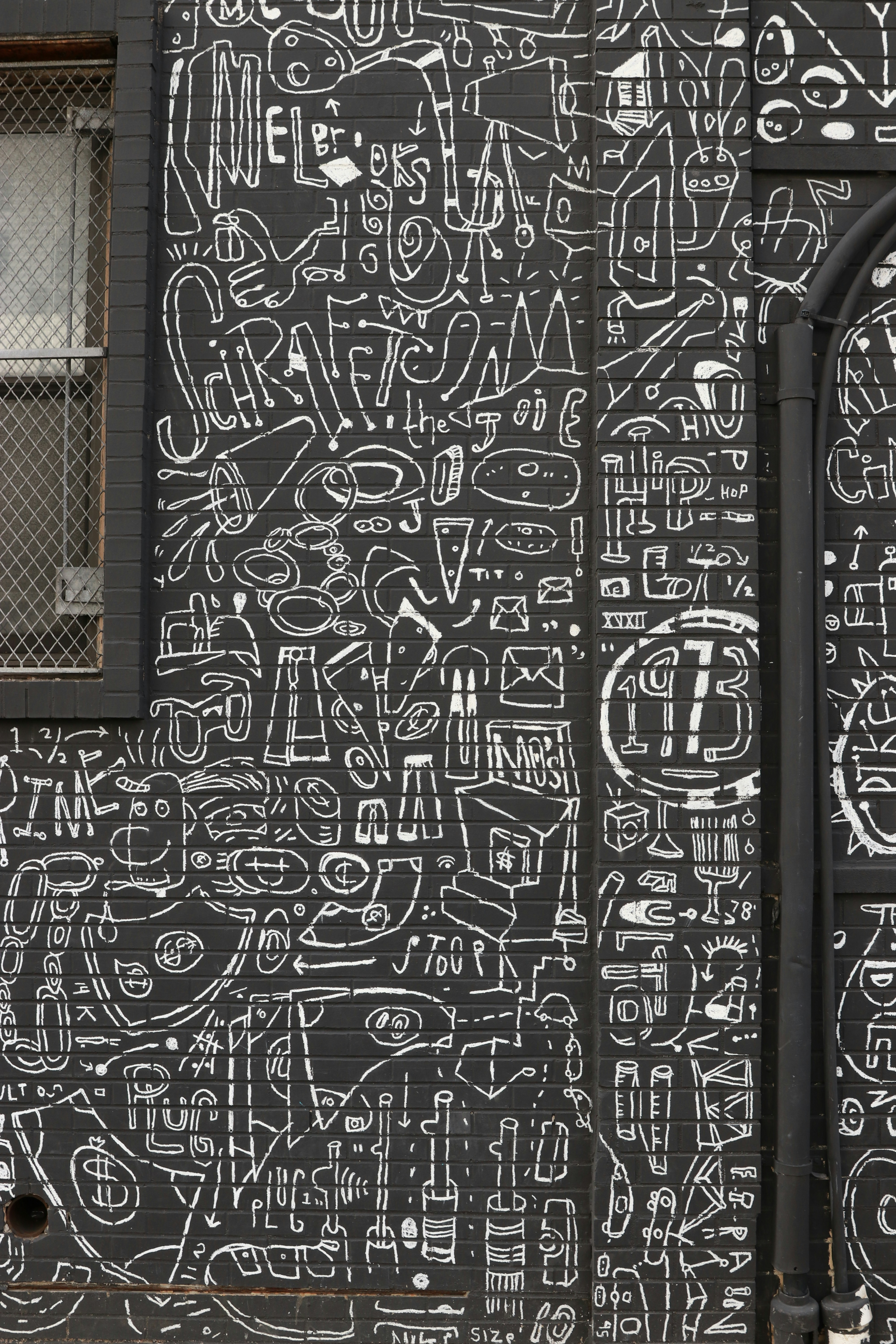 Chalkboard Graffiti: A Wall of Doodles and Symbols