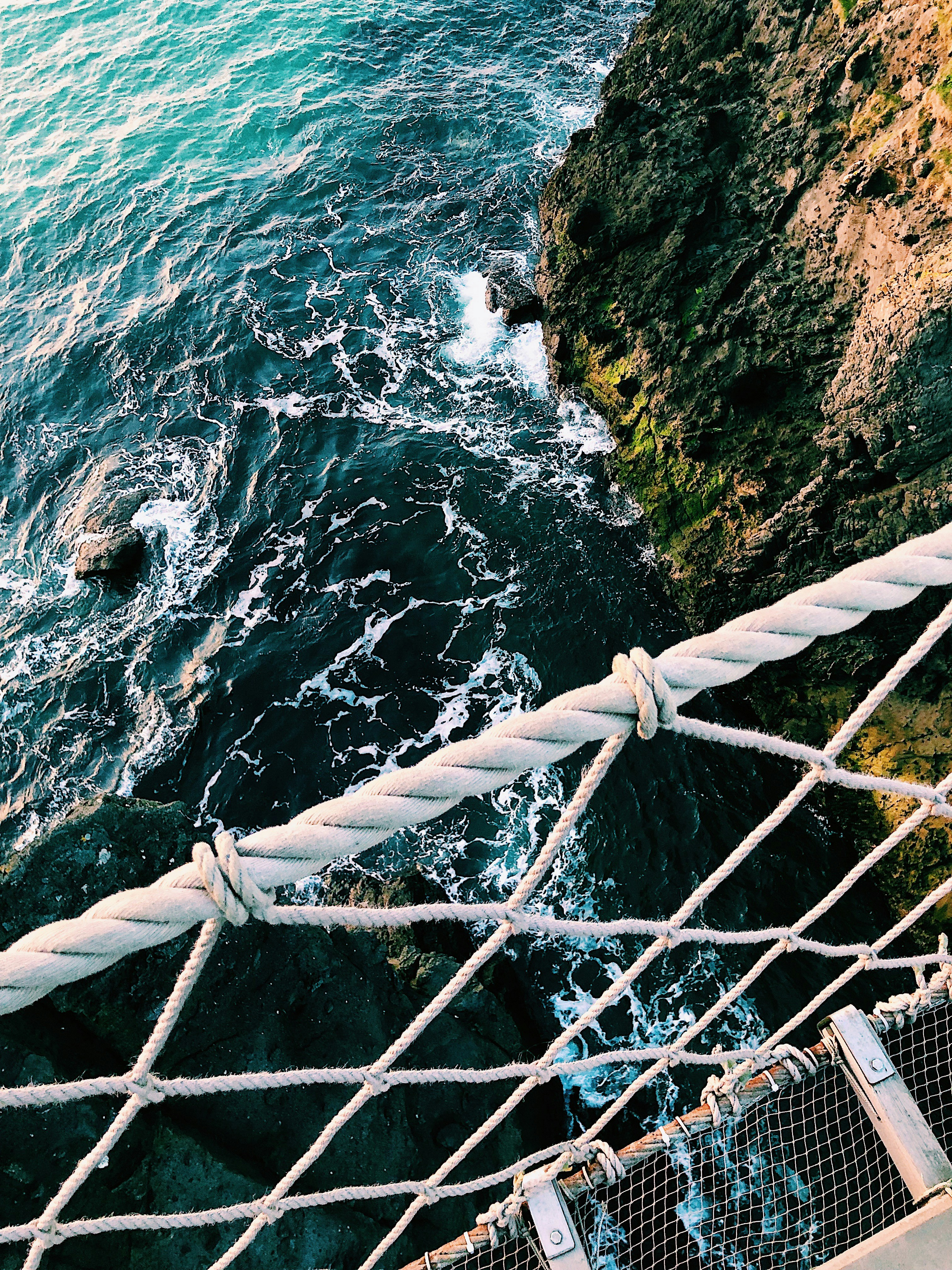 Rope-Guarded Edge: Where Cliff Meets the Turquoise Surge