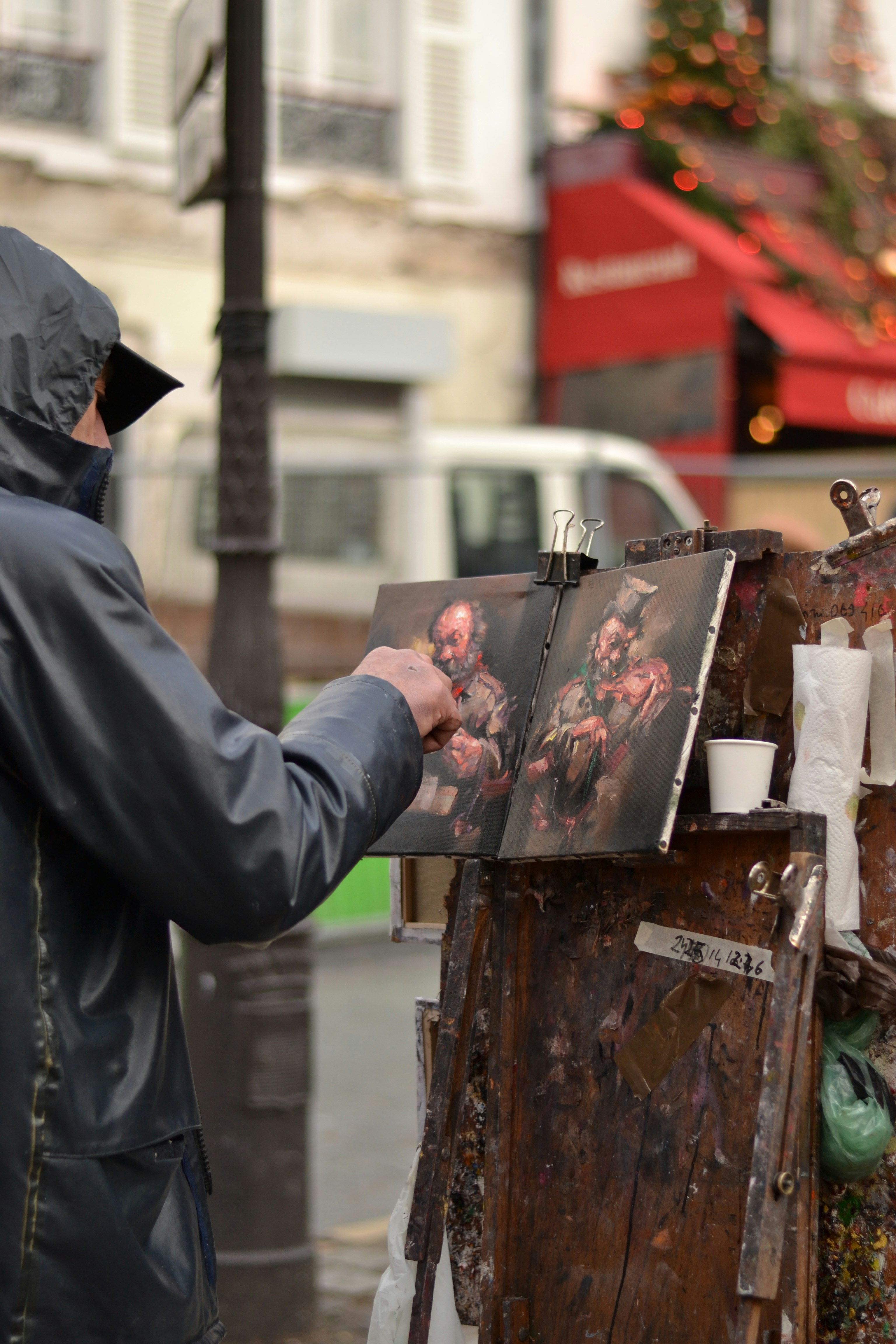 person in black jacket in front of painting