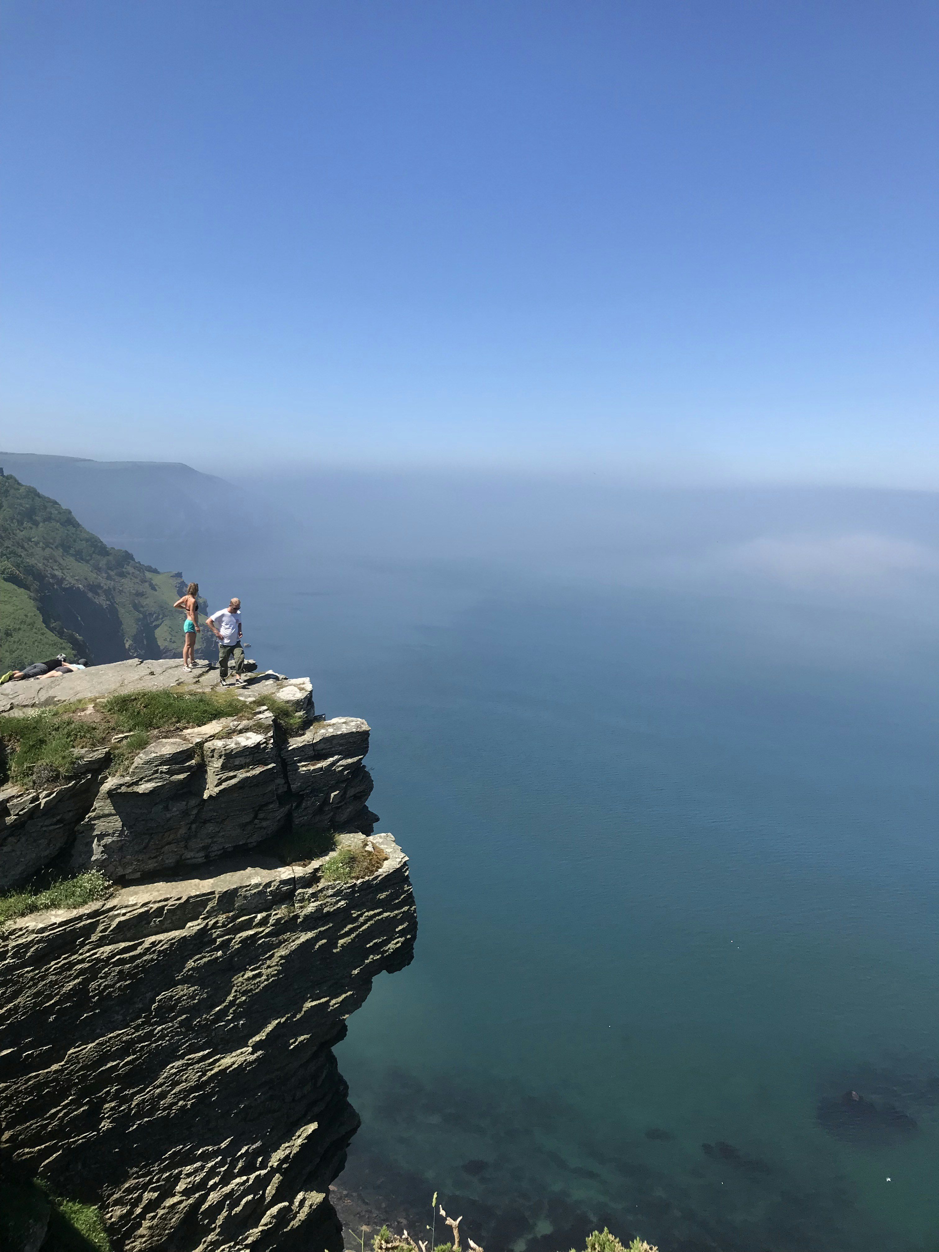 Two persons standing on cliff photo – Free S w coast path Image on Unsplash