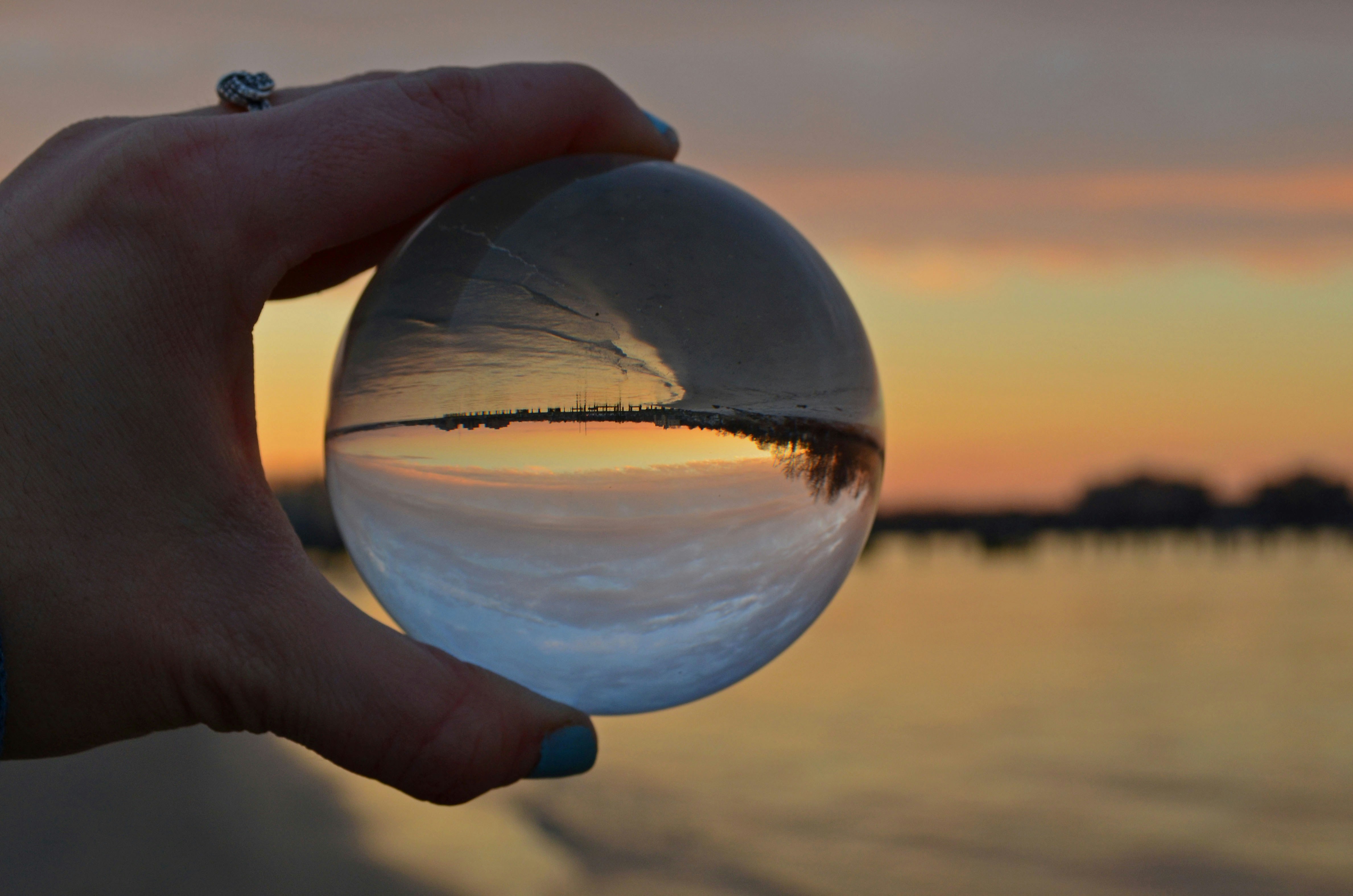 Glass Sphere Framing a Sunset Horizon