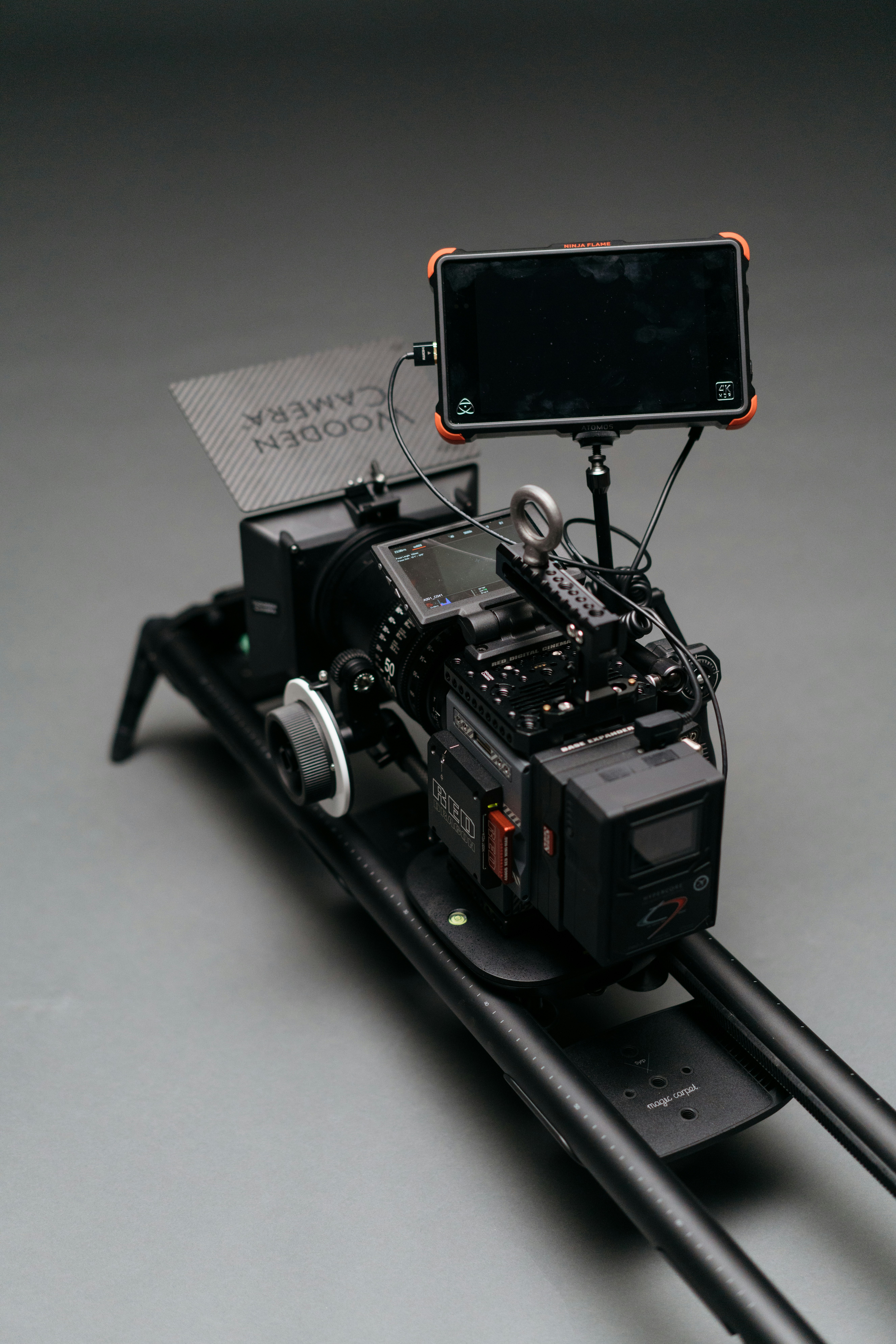 A professional camera setup featuring a Sony Alpha 7R II, mounted on a slider with an external monitor and accessories for dynamic filming.