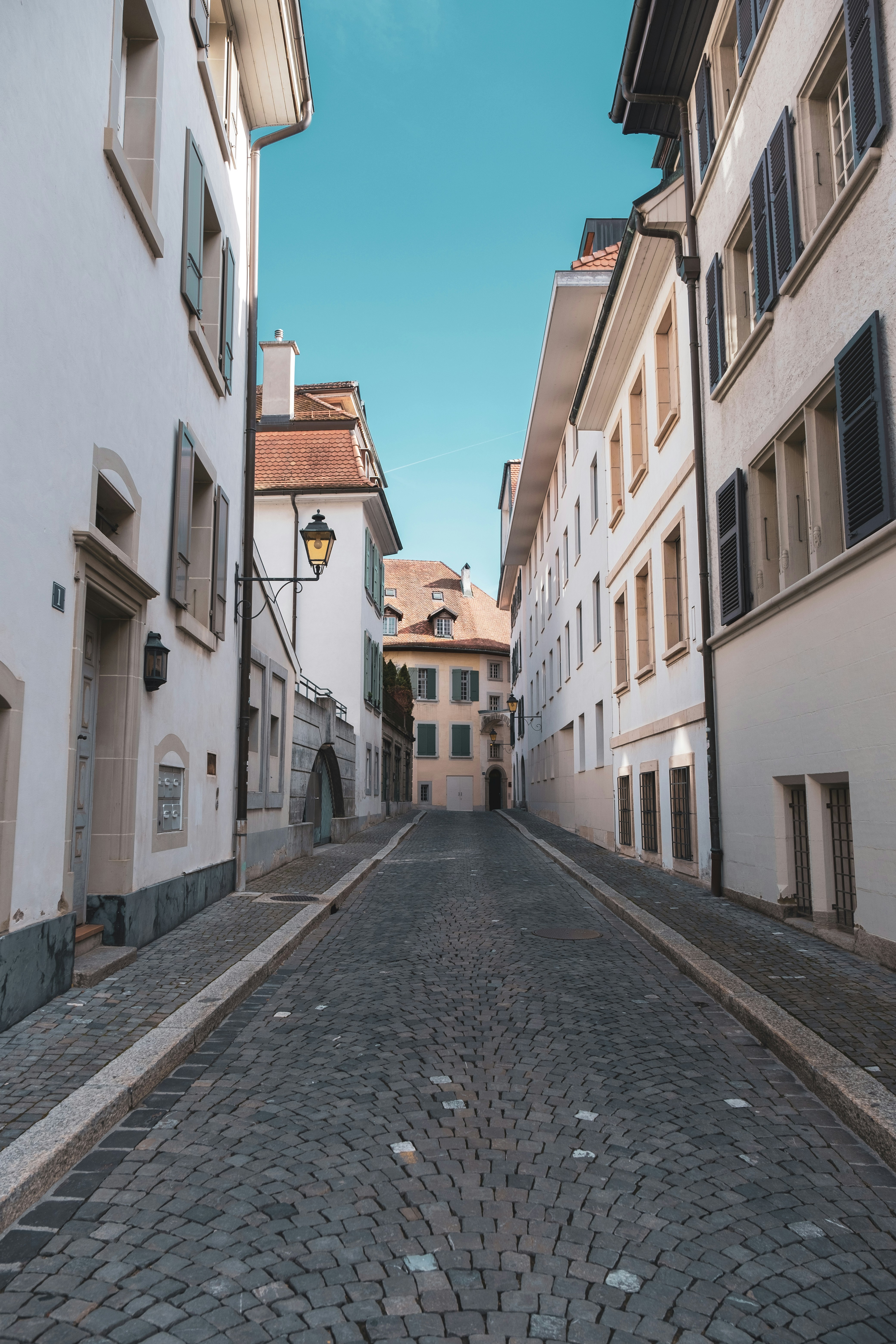 A typical street in the centre of Lausanne's old town district. | white painted houses