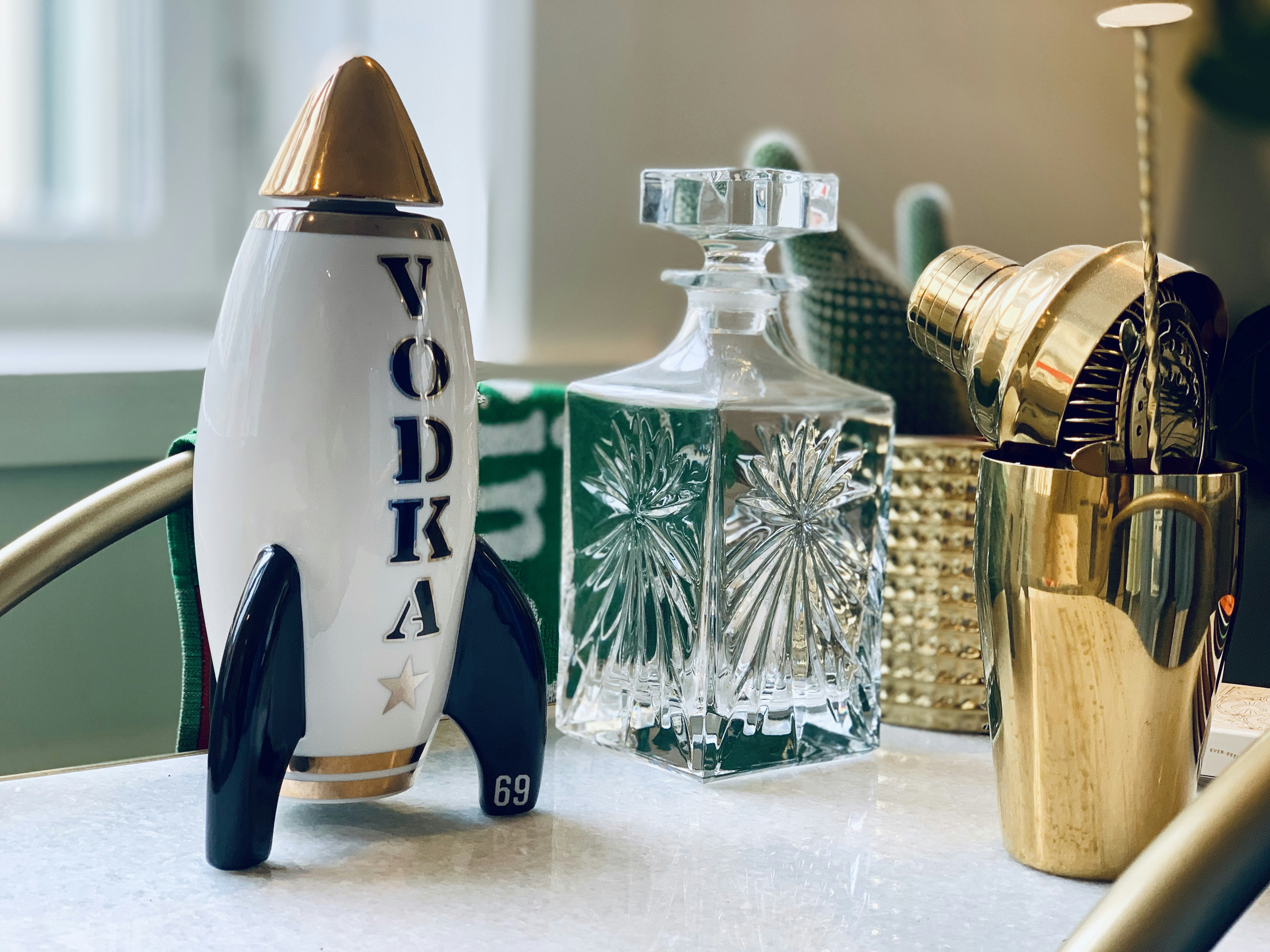 Rocket-shaped Vodka Bottle Leads a Shelf of Crystal and Brass