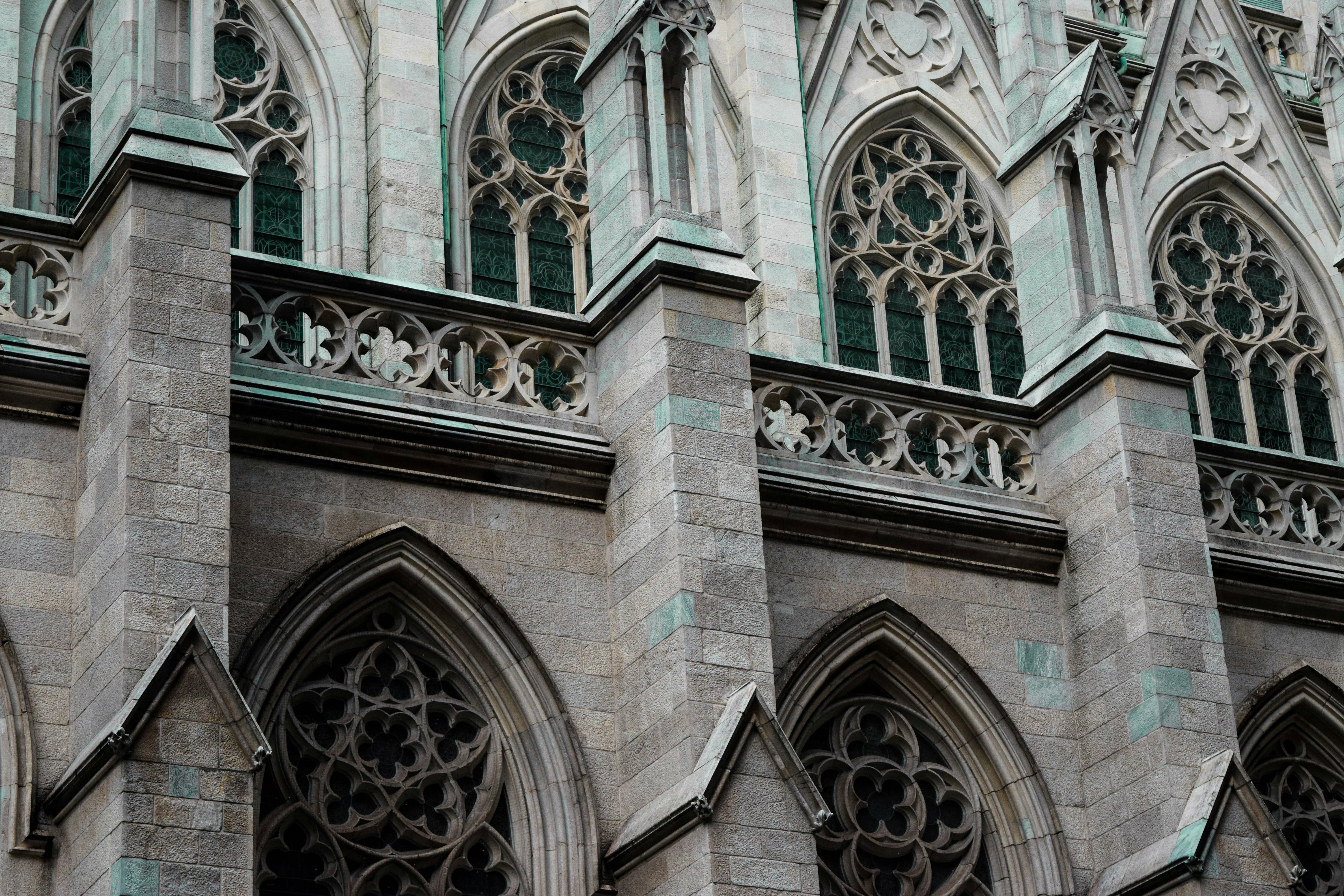 Intricate stonework and pointed arches of St. Patrick's Cathedral facade in New York City.