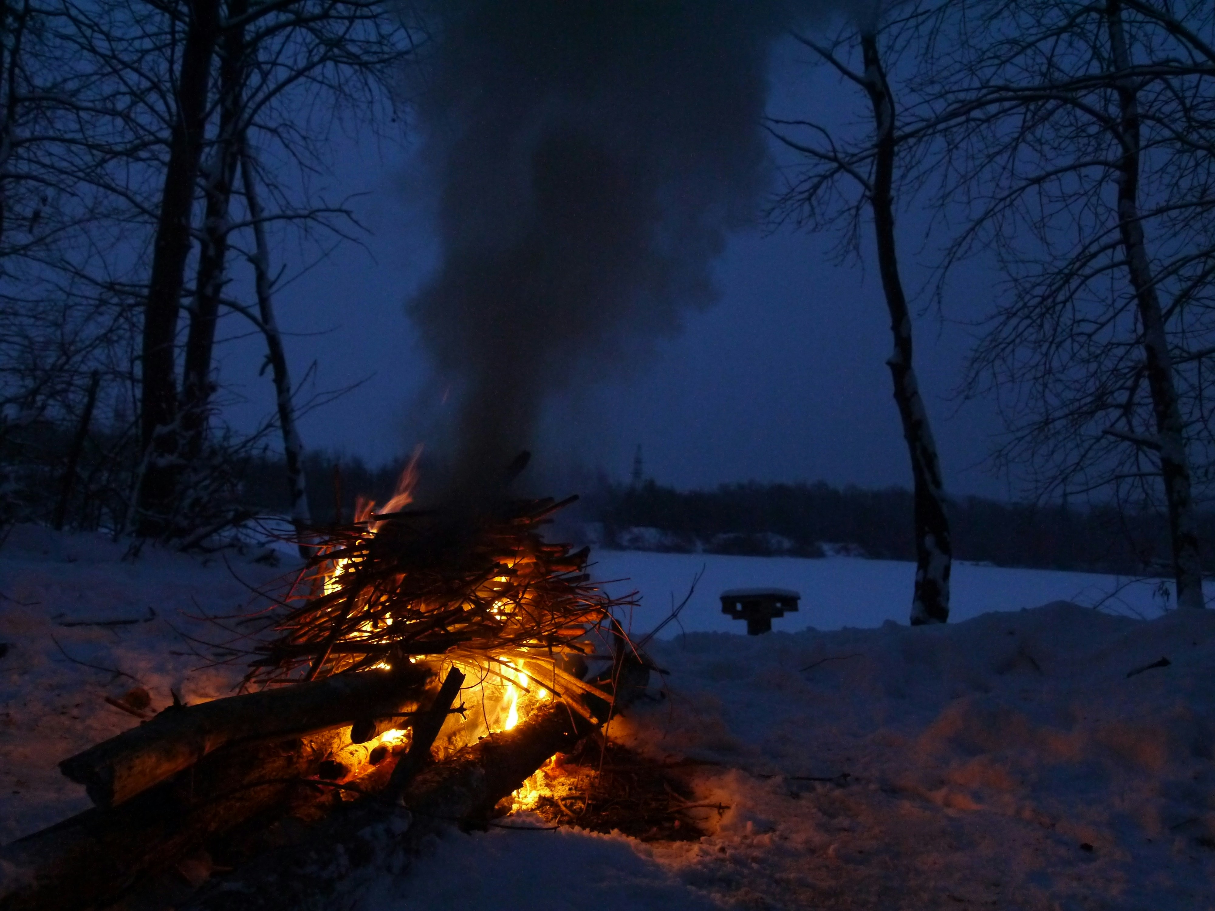 Midwinter Ember: A Lone Bonfire Against a Snowbound Evening