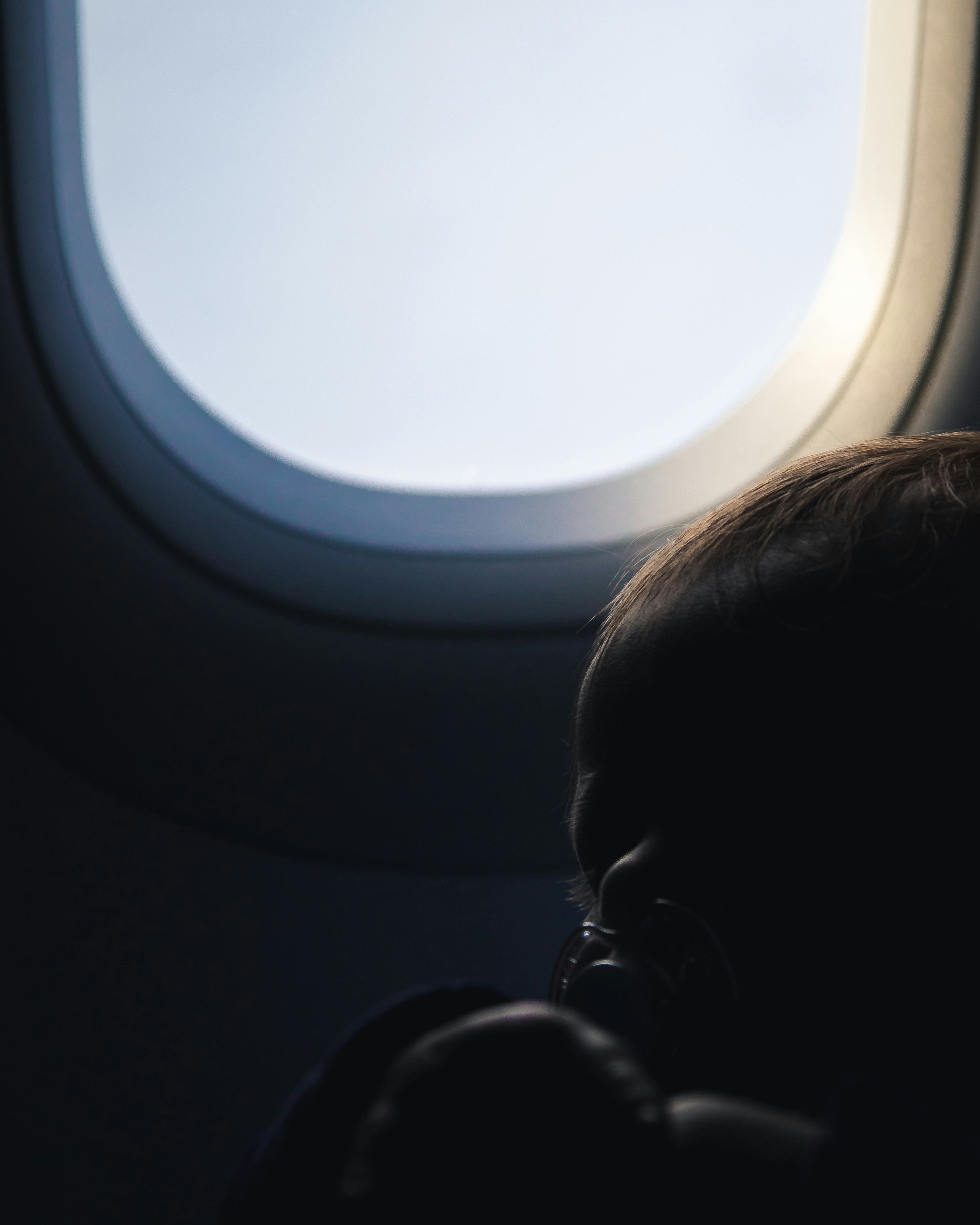Skyframe at 30,000 Feet: A Quiet Silhouette by the Window