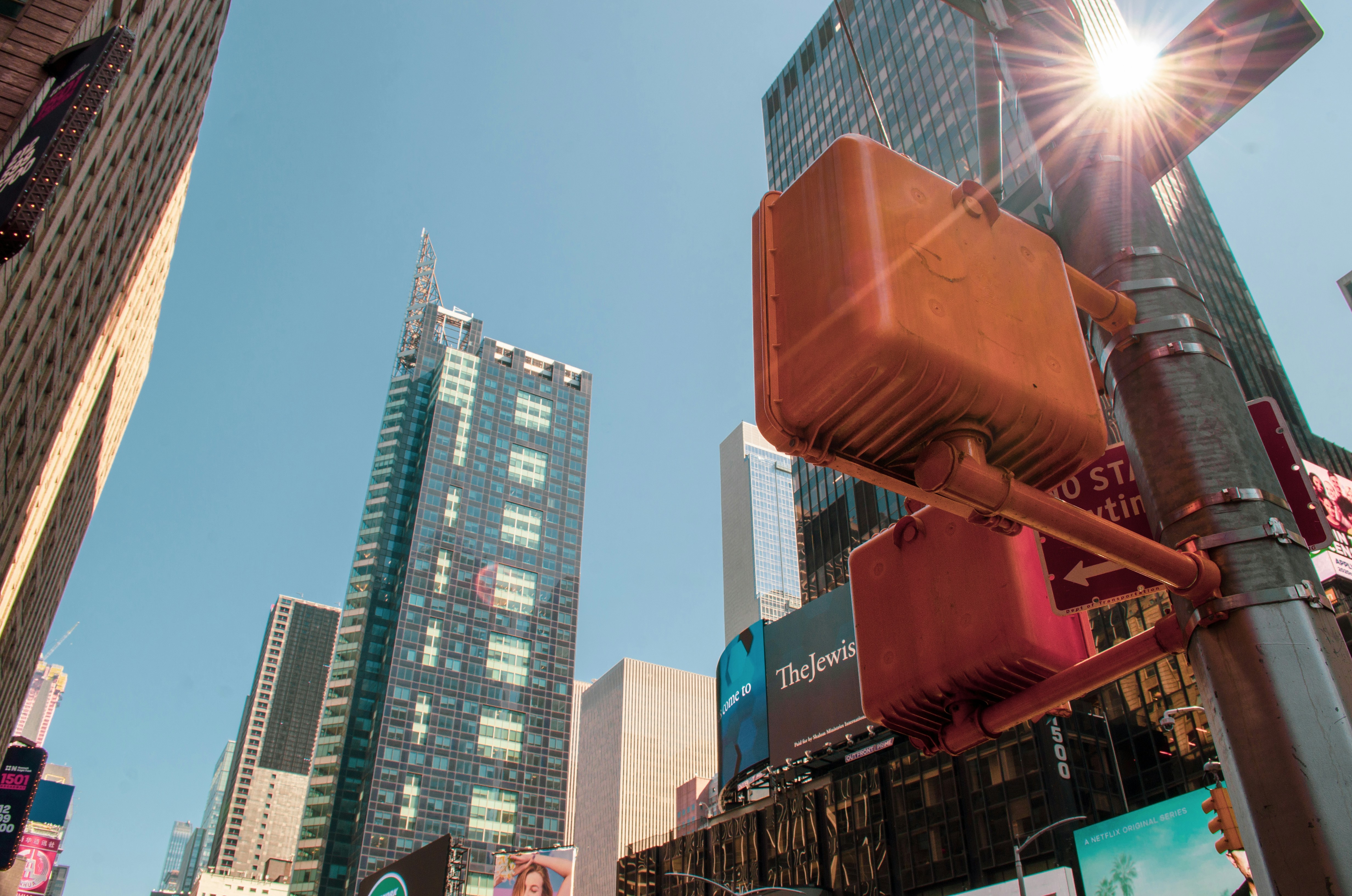 Traffic signs near high-rise buildings photo – Free Light Image on Unsplash