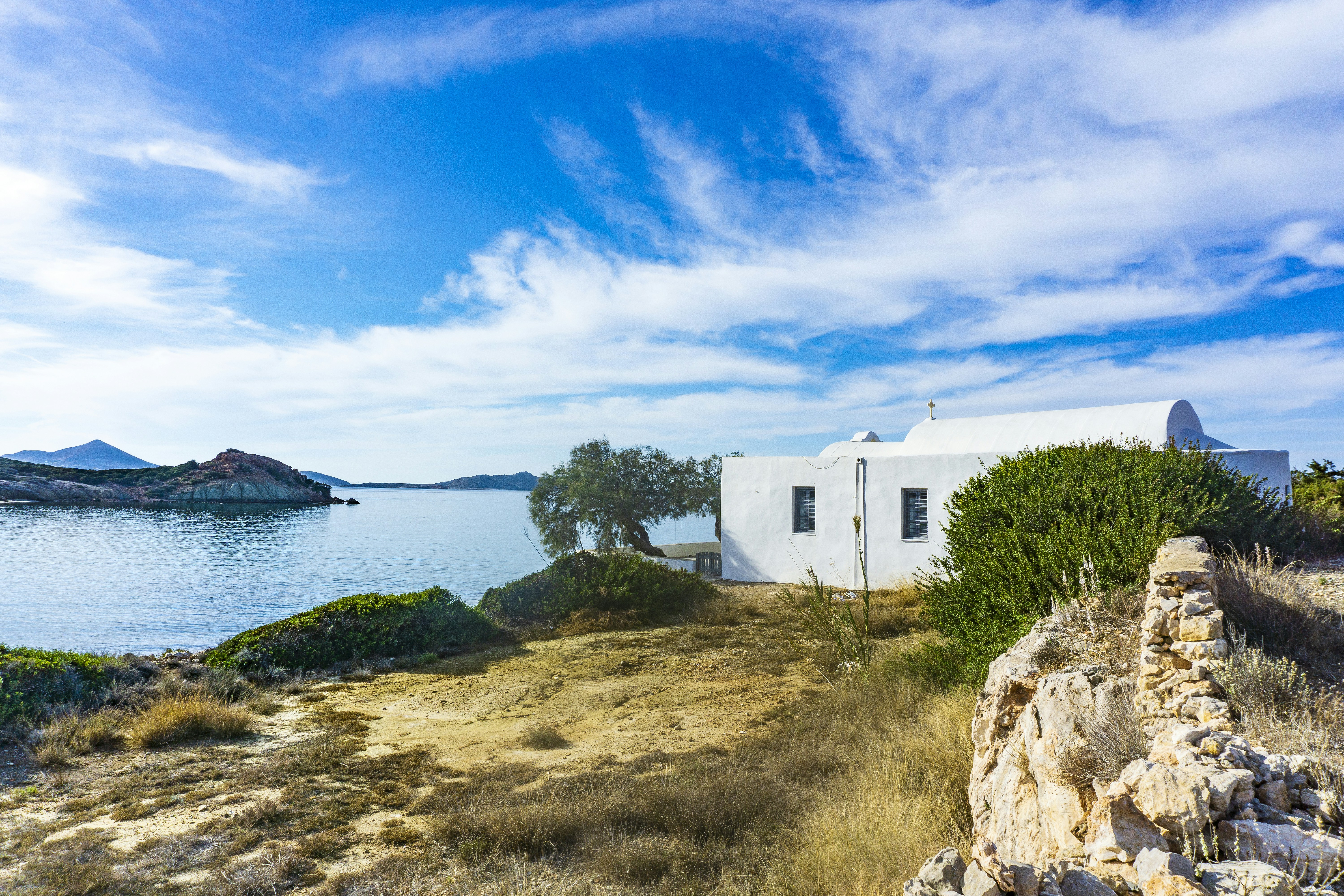 Whitewashed Refuge by the Sea Under a Cerulean Sky