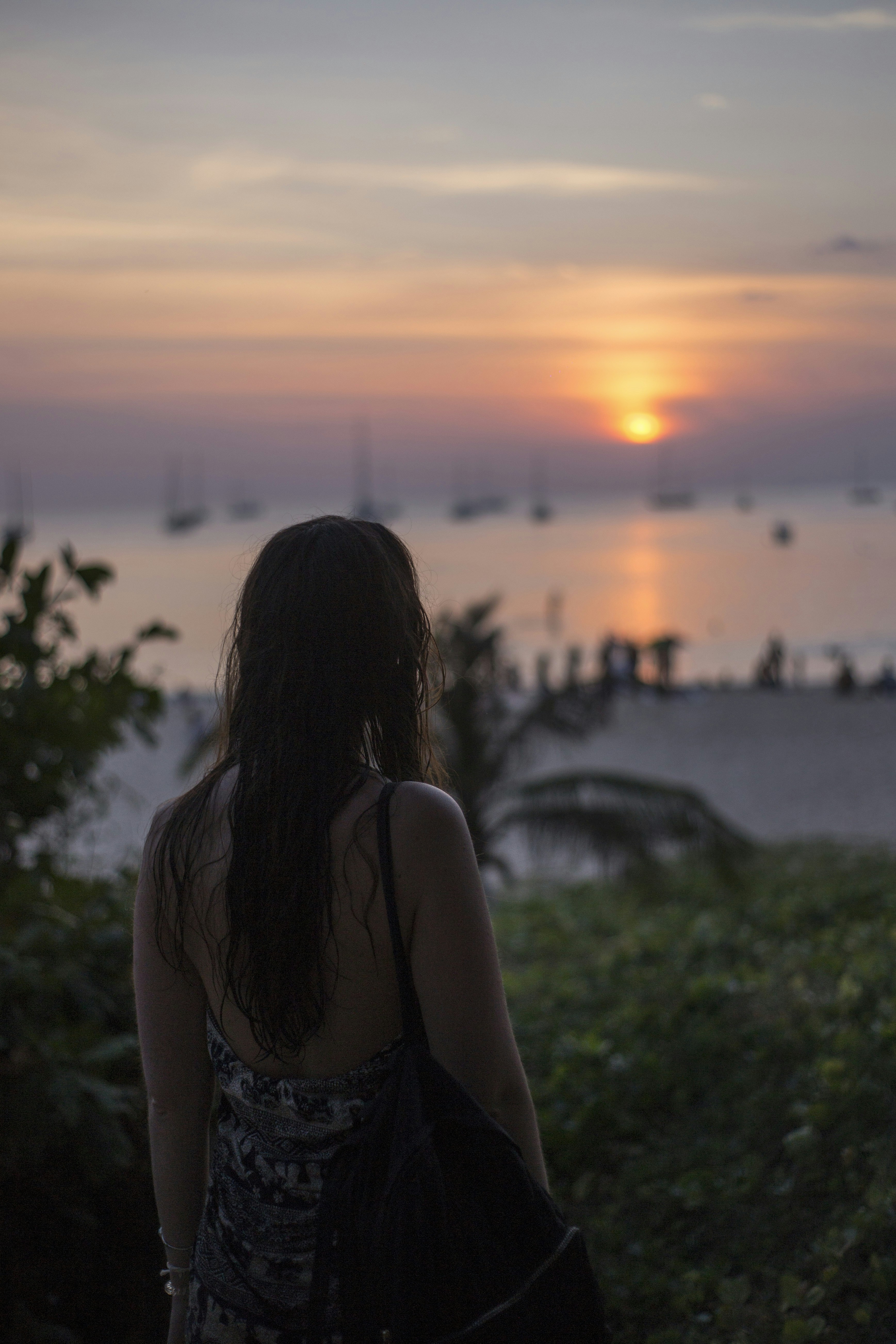 Woman in backless top looking into sunset photo – Free Sílvia Image on ...