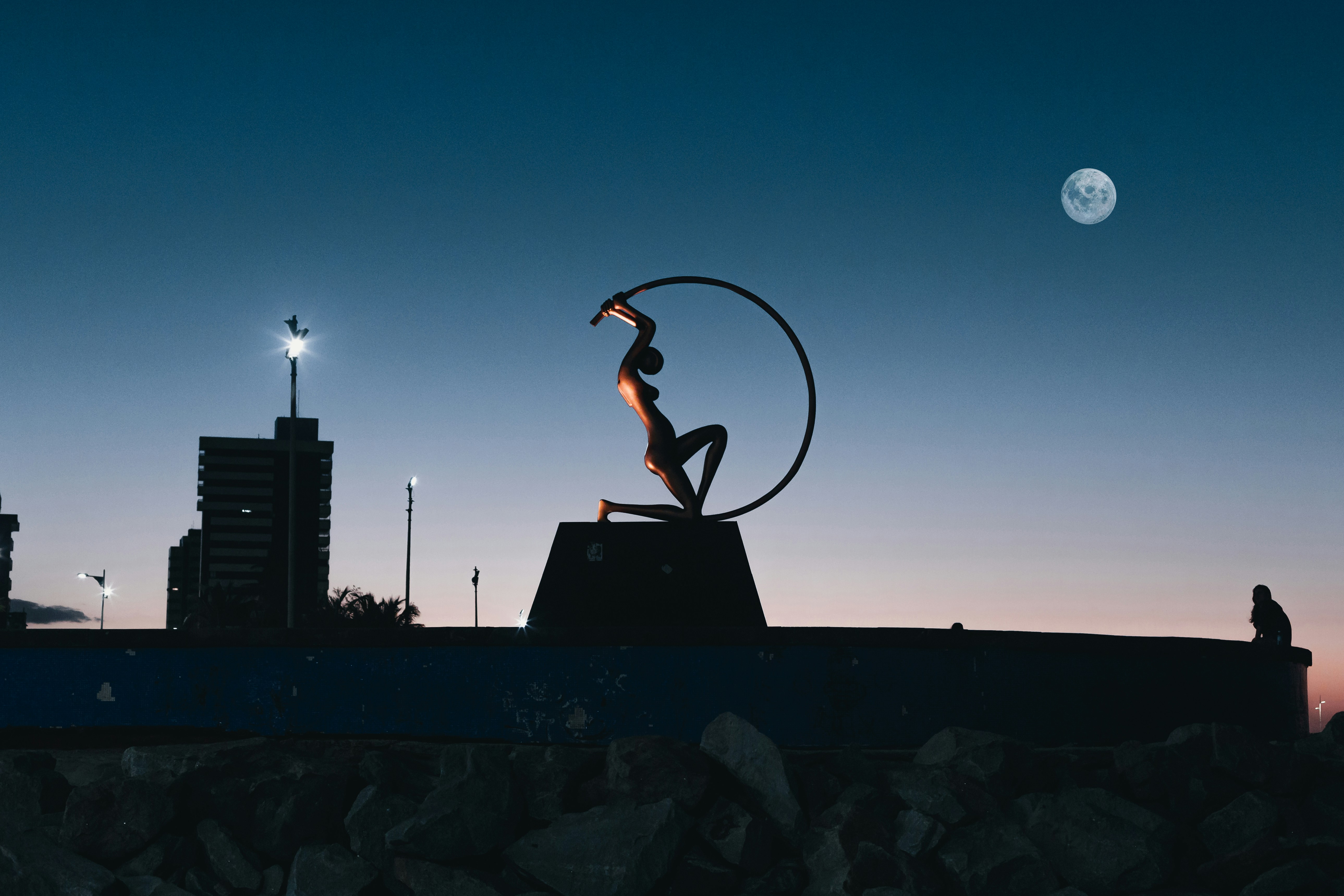 Moonlit Arc: Silhouette Dancer on a Circular Ring