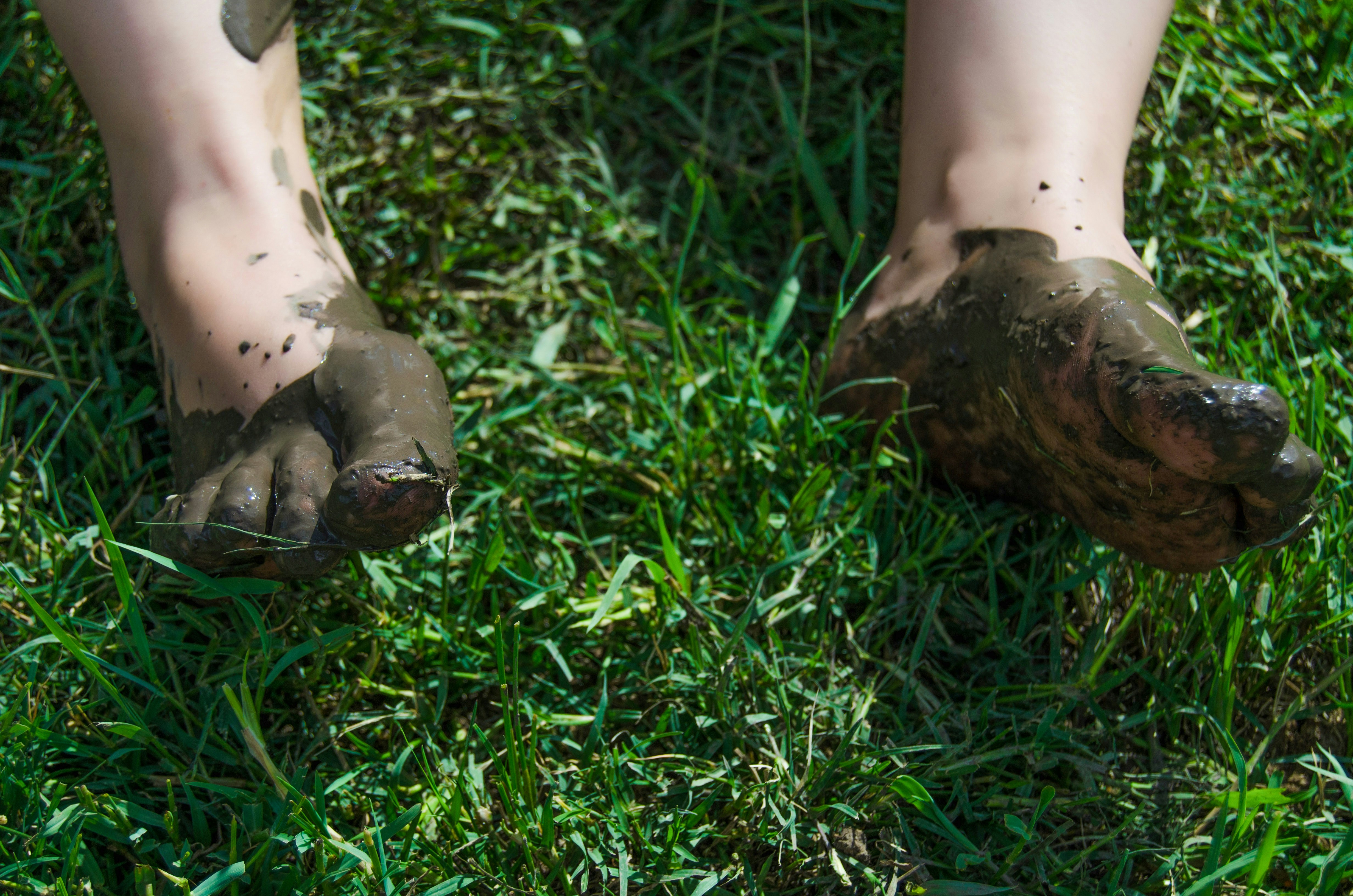 Mud-Caked Toes: A Ground-Level Moment in Green Grass