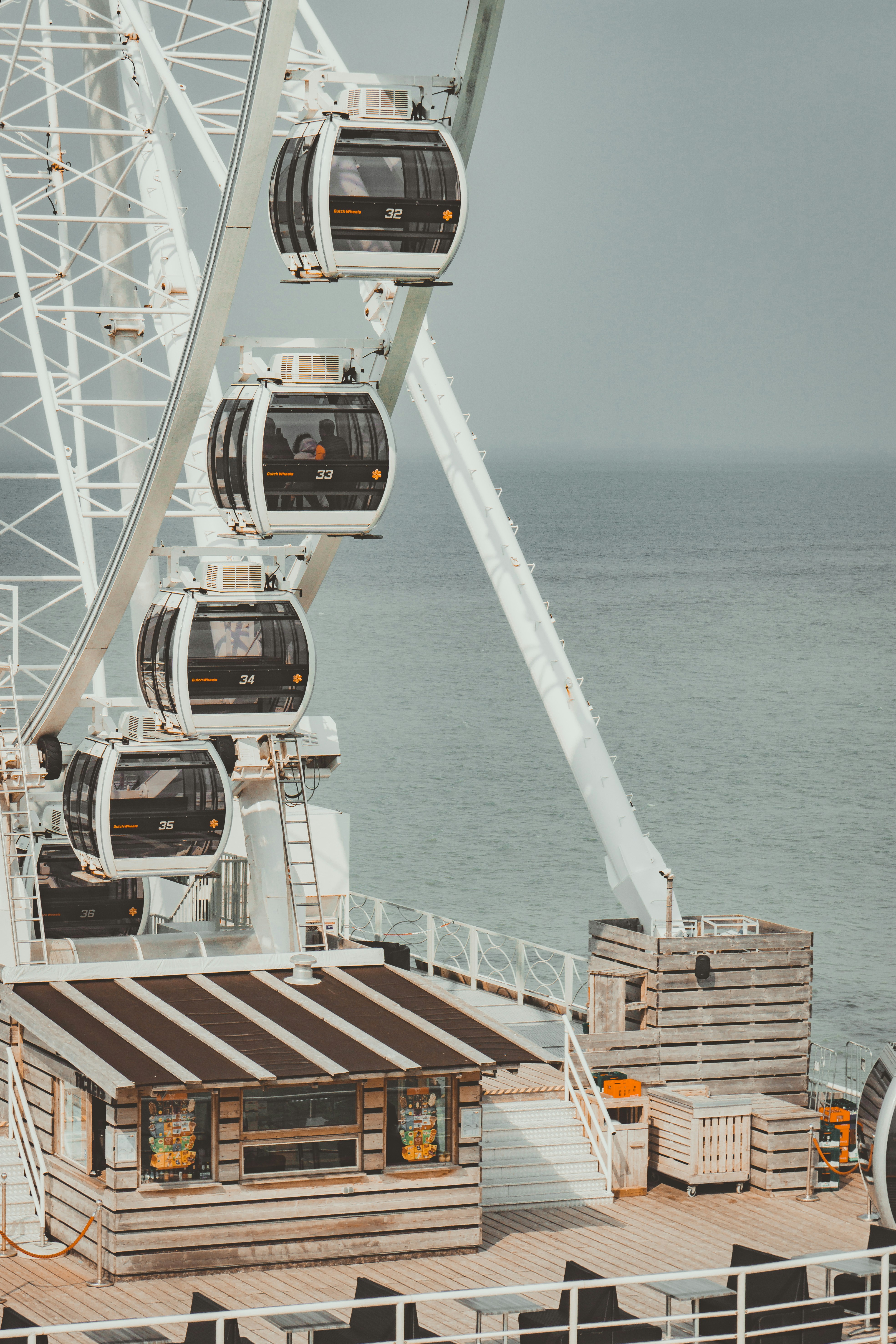 Ferris Wheel Silhouette Over Ocean Deck