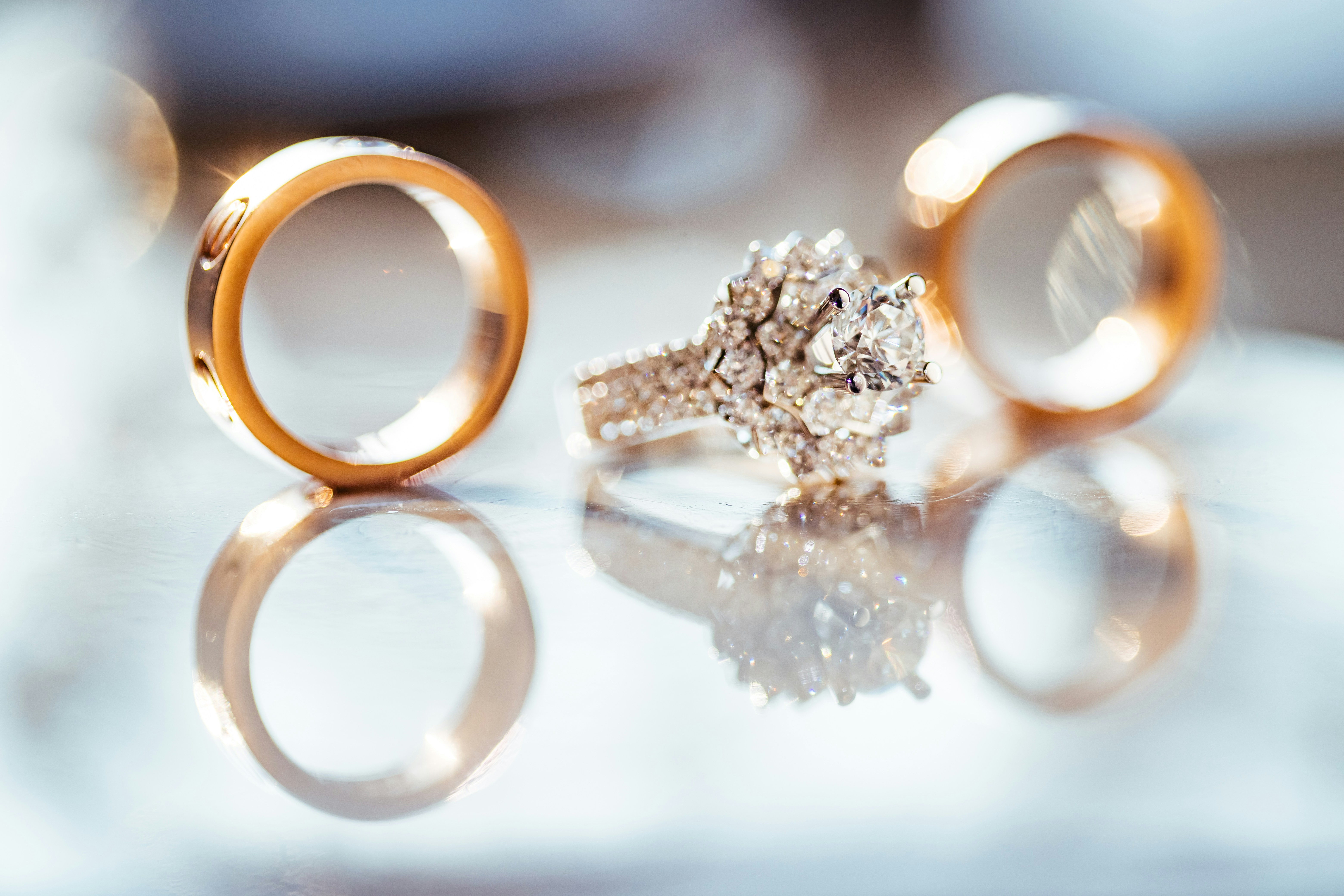 A couple of rings sitting on top of a table photo – Free Wedding Image ...