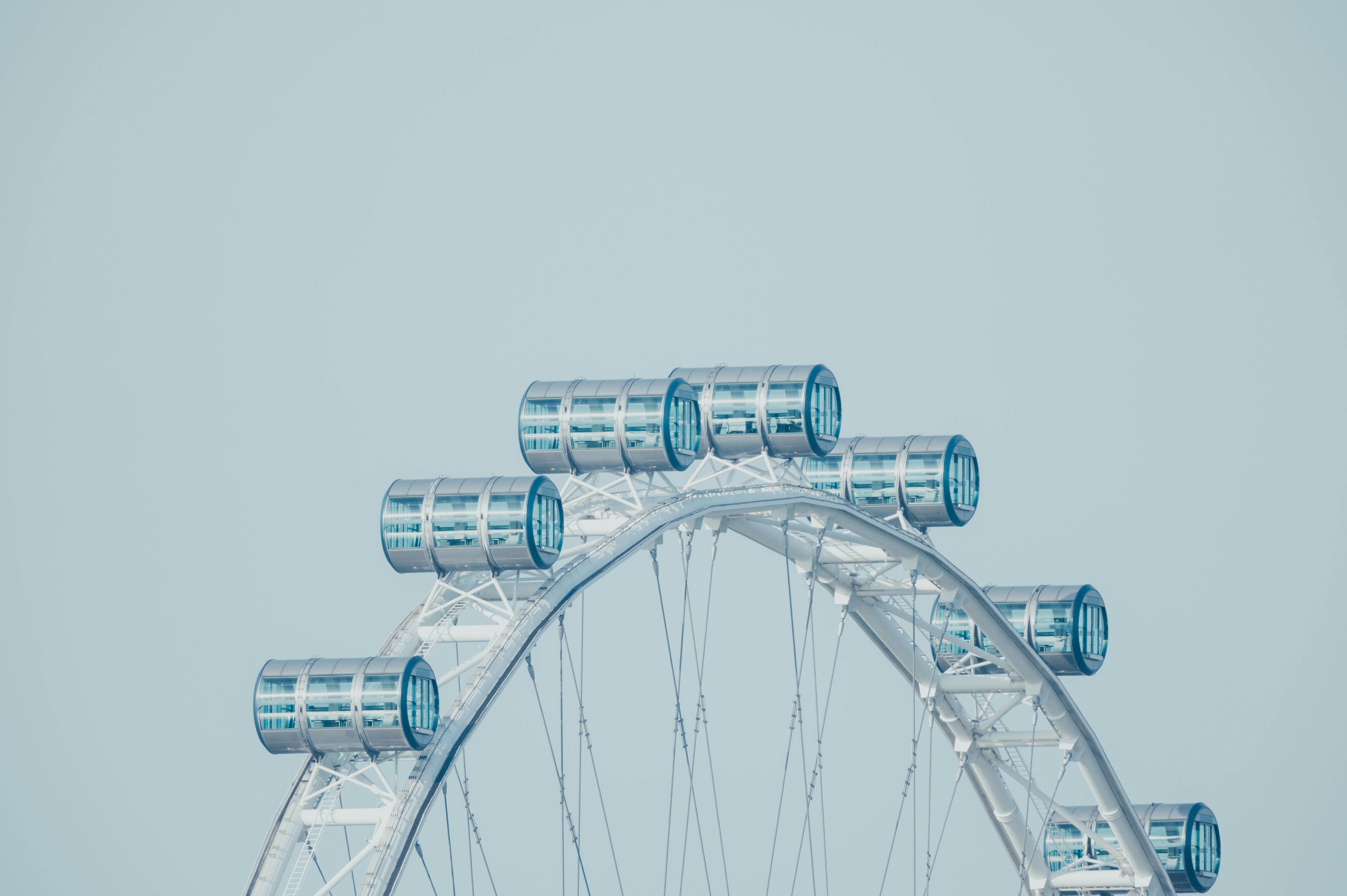 A large ferris wheel with several buckets on top of it photo – Free ...