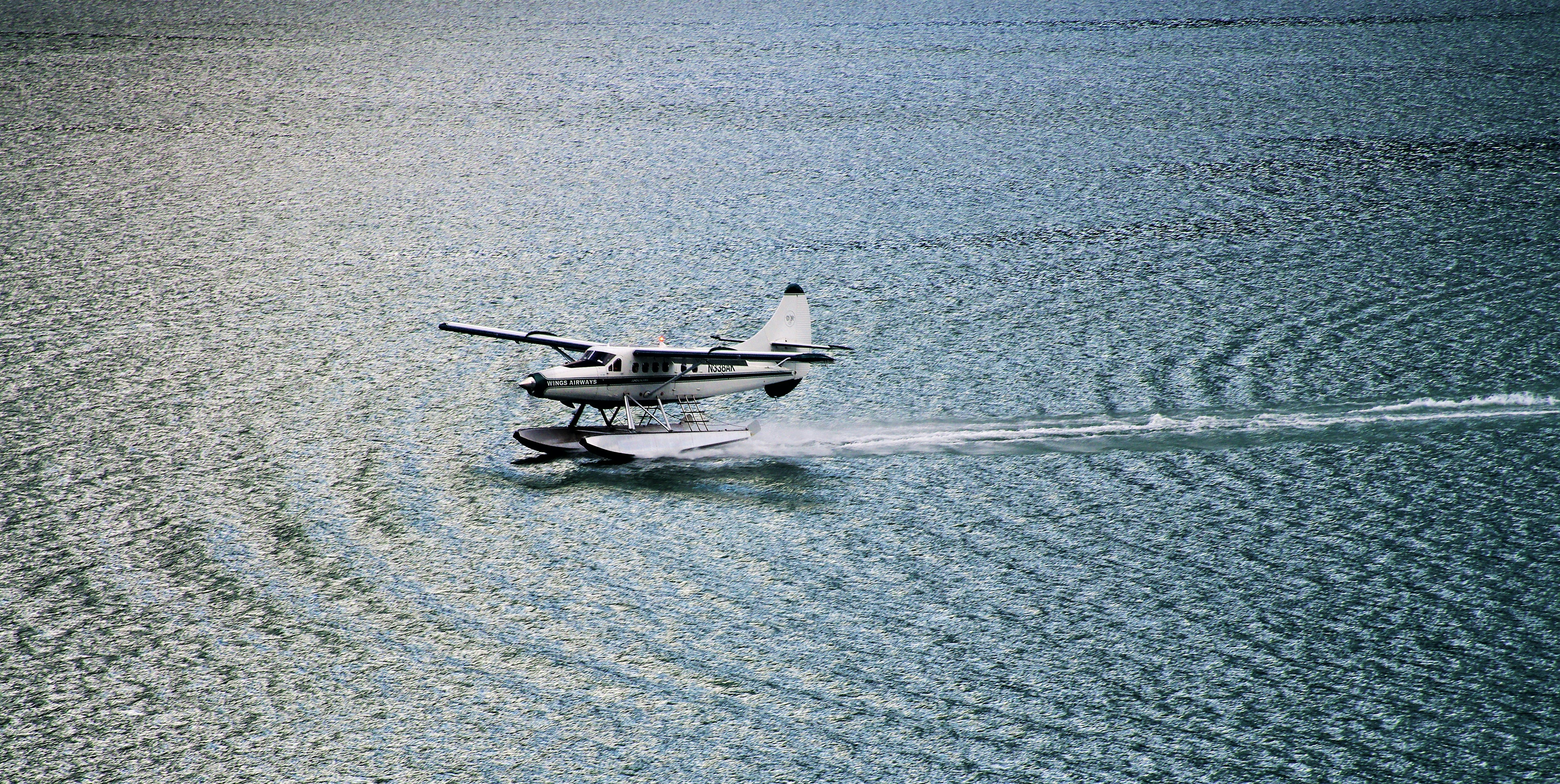 Skimming Wake: A Small Seaplane Slices Quiet Blue