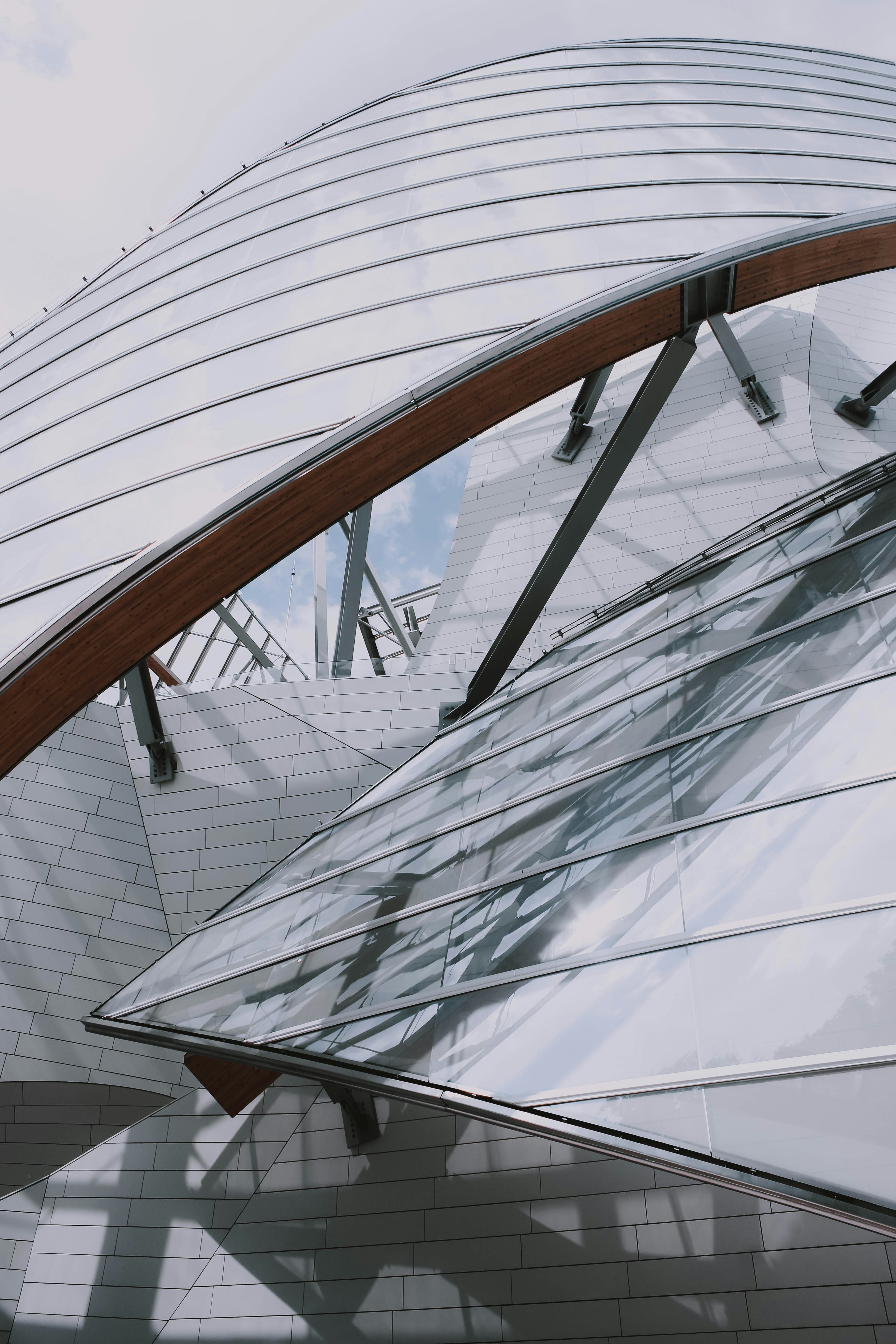 A curved metal structure with a sky background photo – Free Building ...