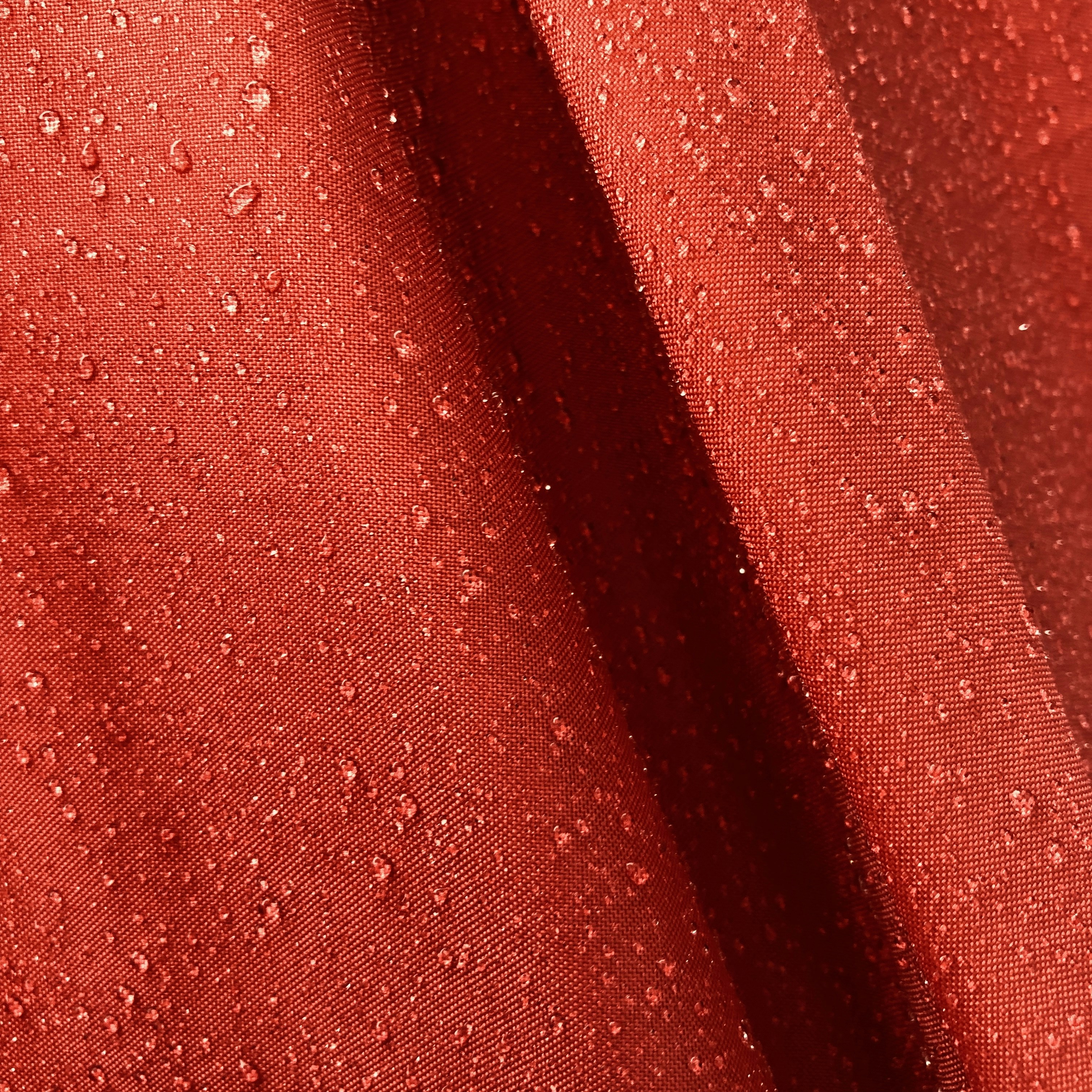 Raindrops Dance on Crimson Fabric