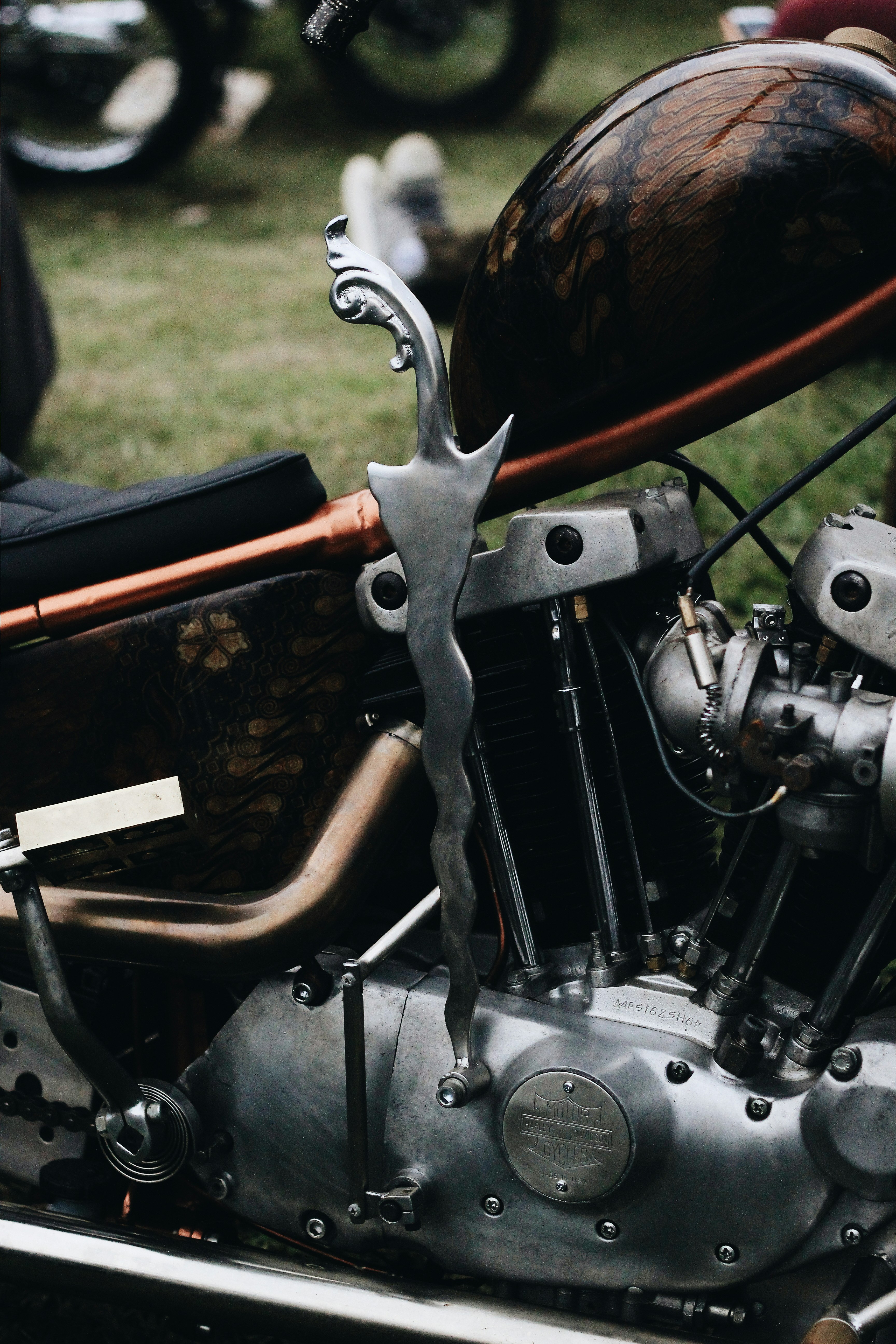 Chrome-Curved Lever Amidst a Vintage Motorcycle's Mechanical Heart