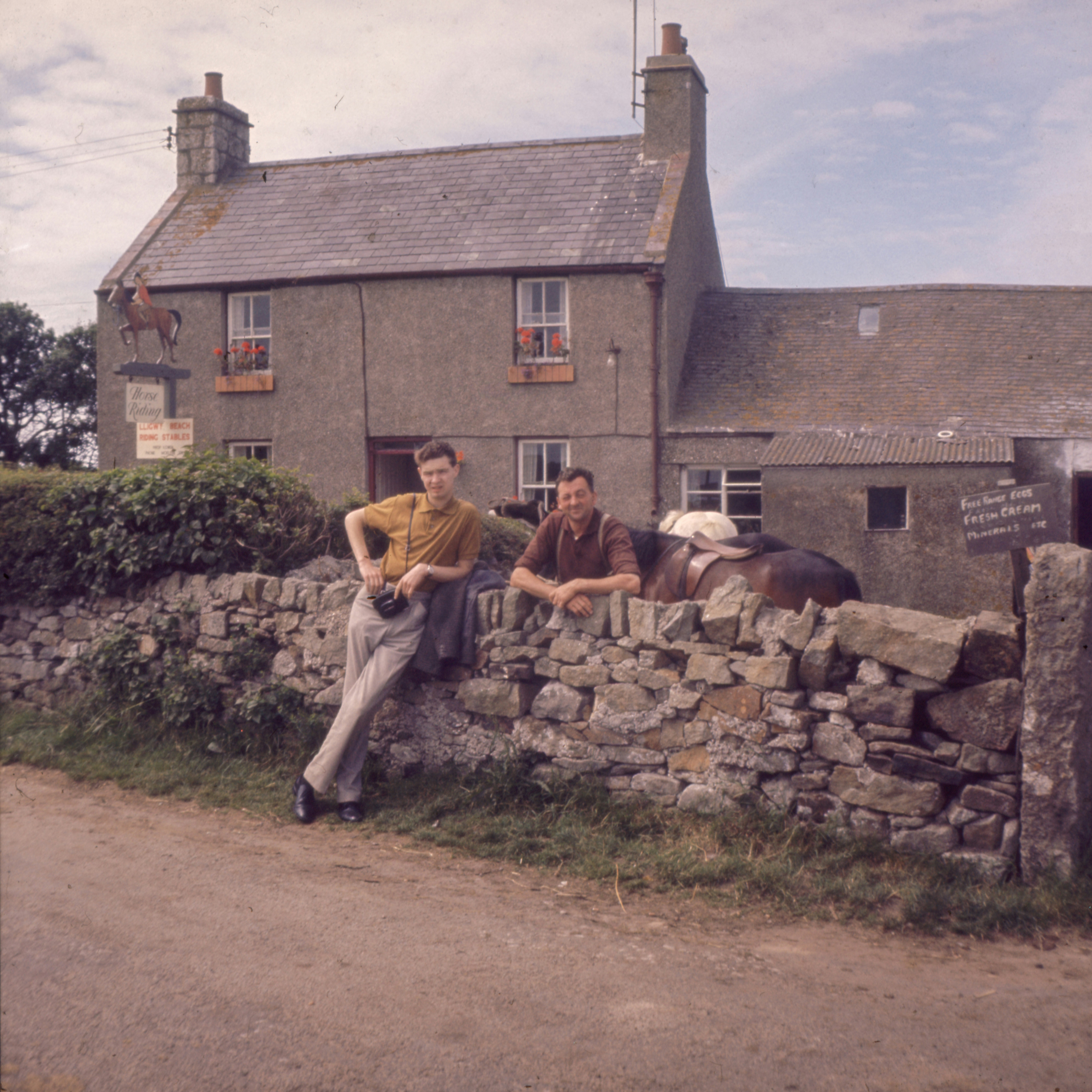 Two men standing beside gray concrete house photo – Free Analog ...