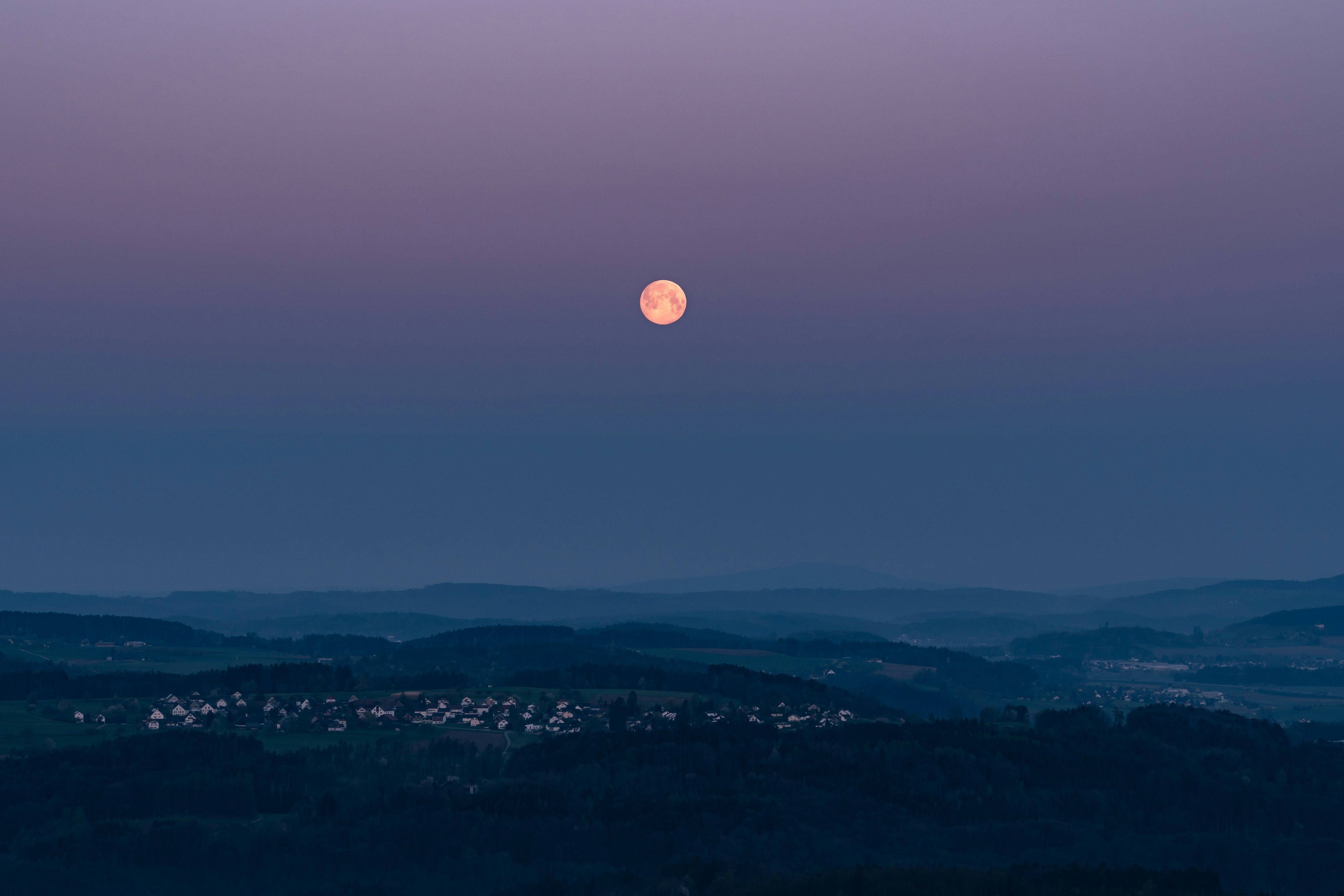 moonset short before sunrise on good friday | aerial photography of buildings