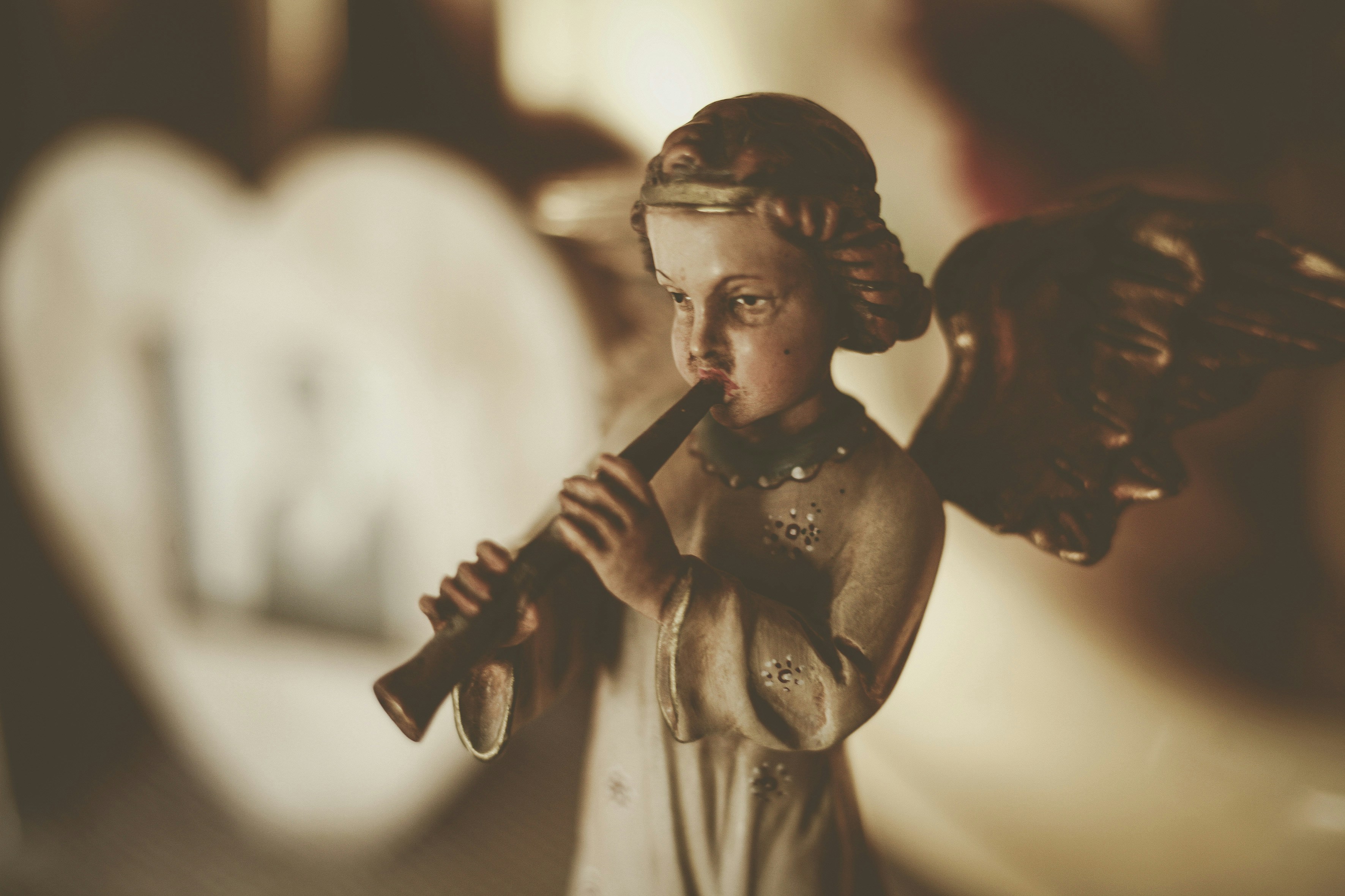Brown ceramic angel playing flute figurine photo – Free Grey Image on ...