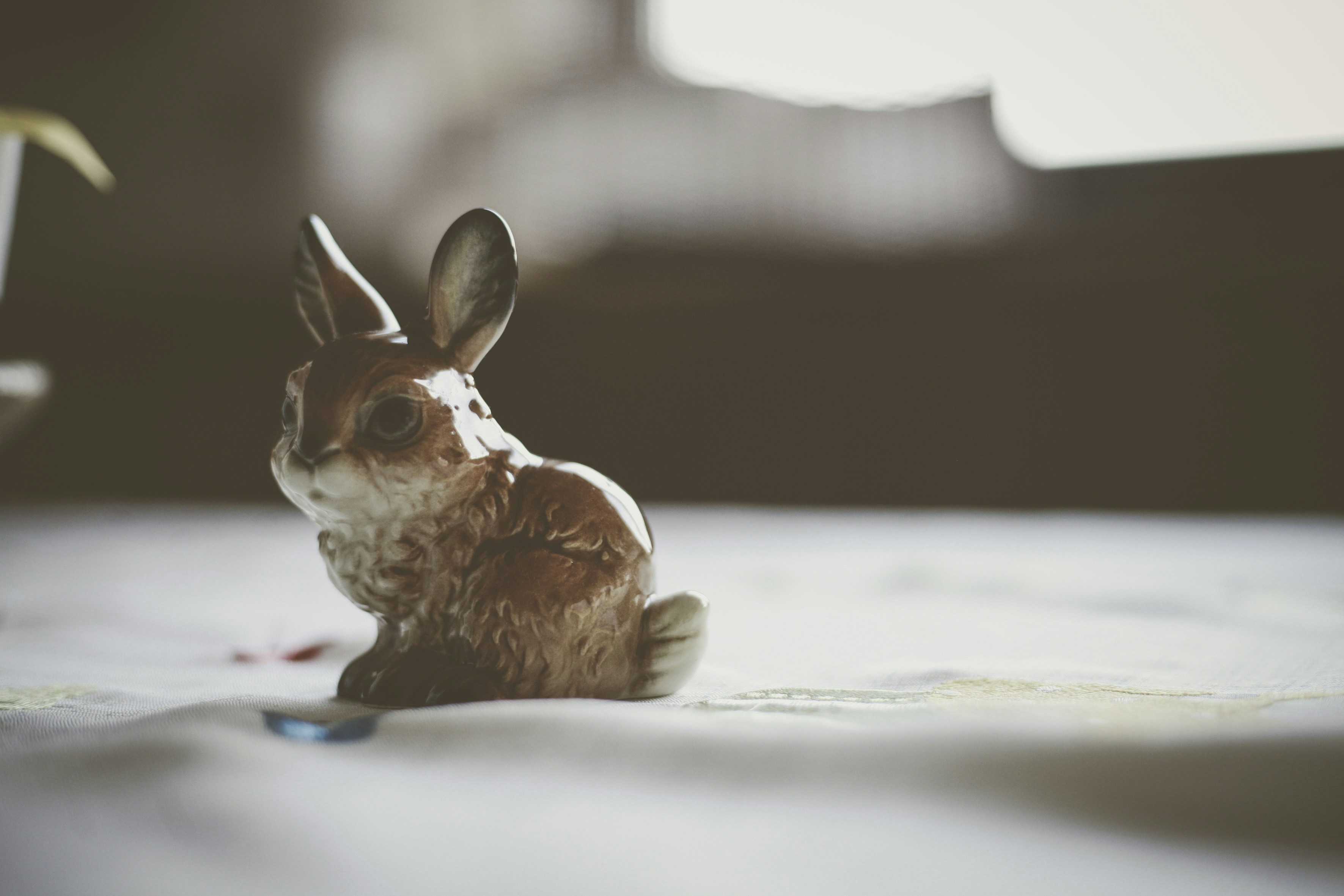selective focus photo of rabbit figurine