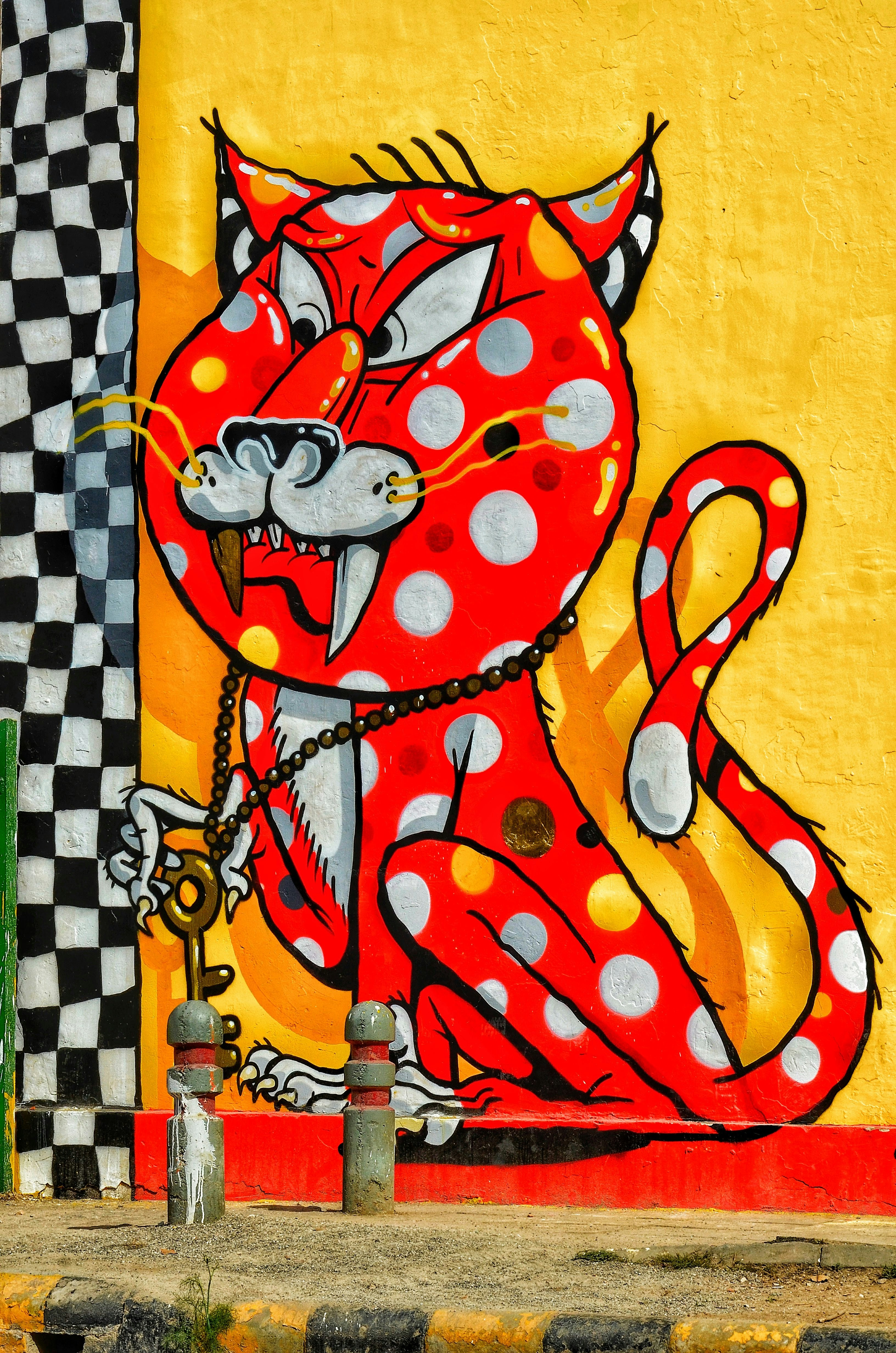 Bright Red Dragon graffiti with checkered border on sunlit wall