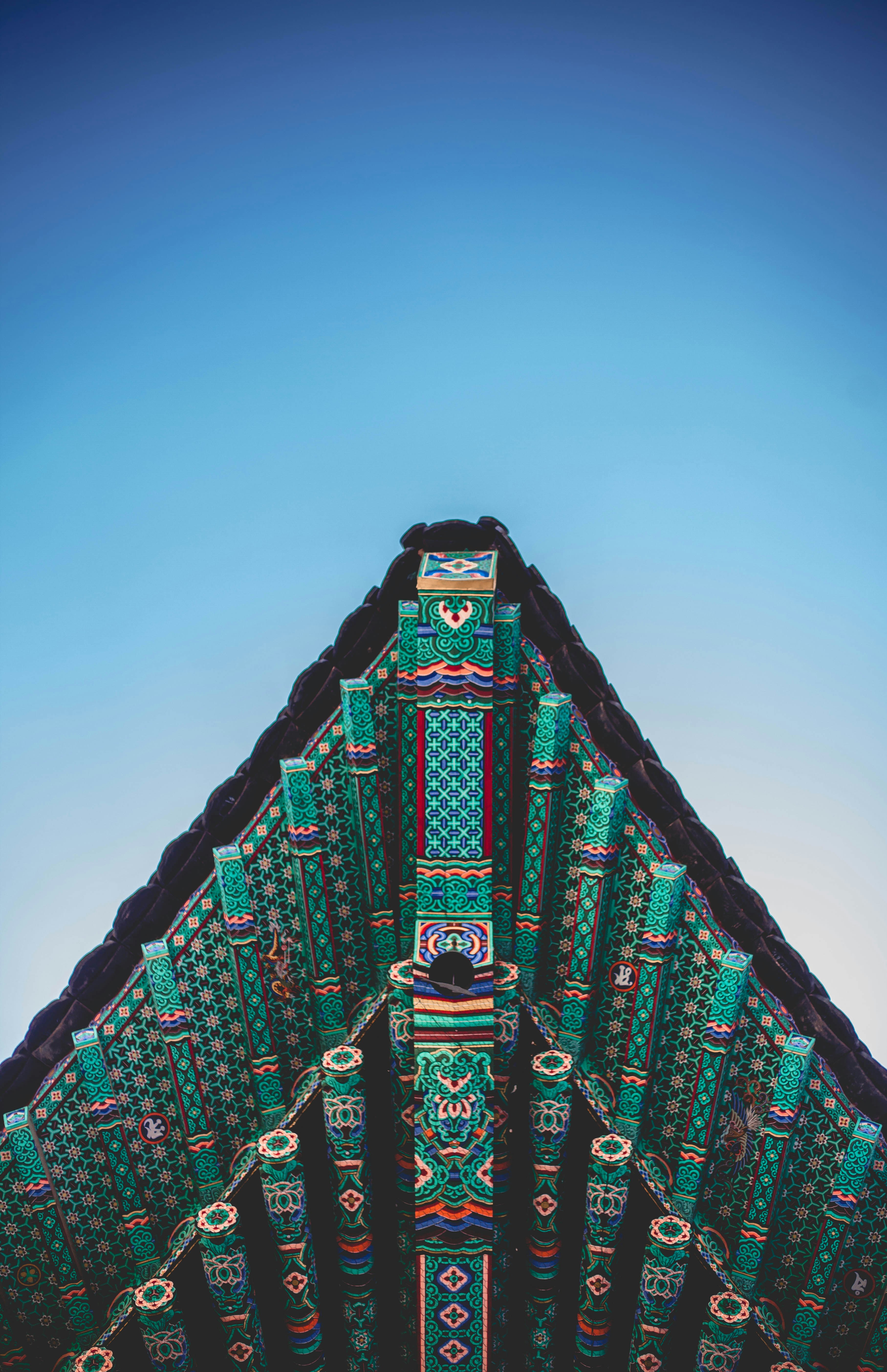 Crest of Emerald Carved Tiles Against a Cerulean Sky