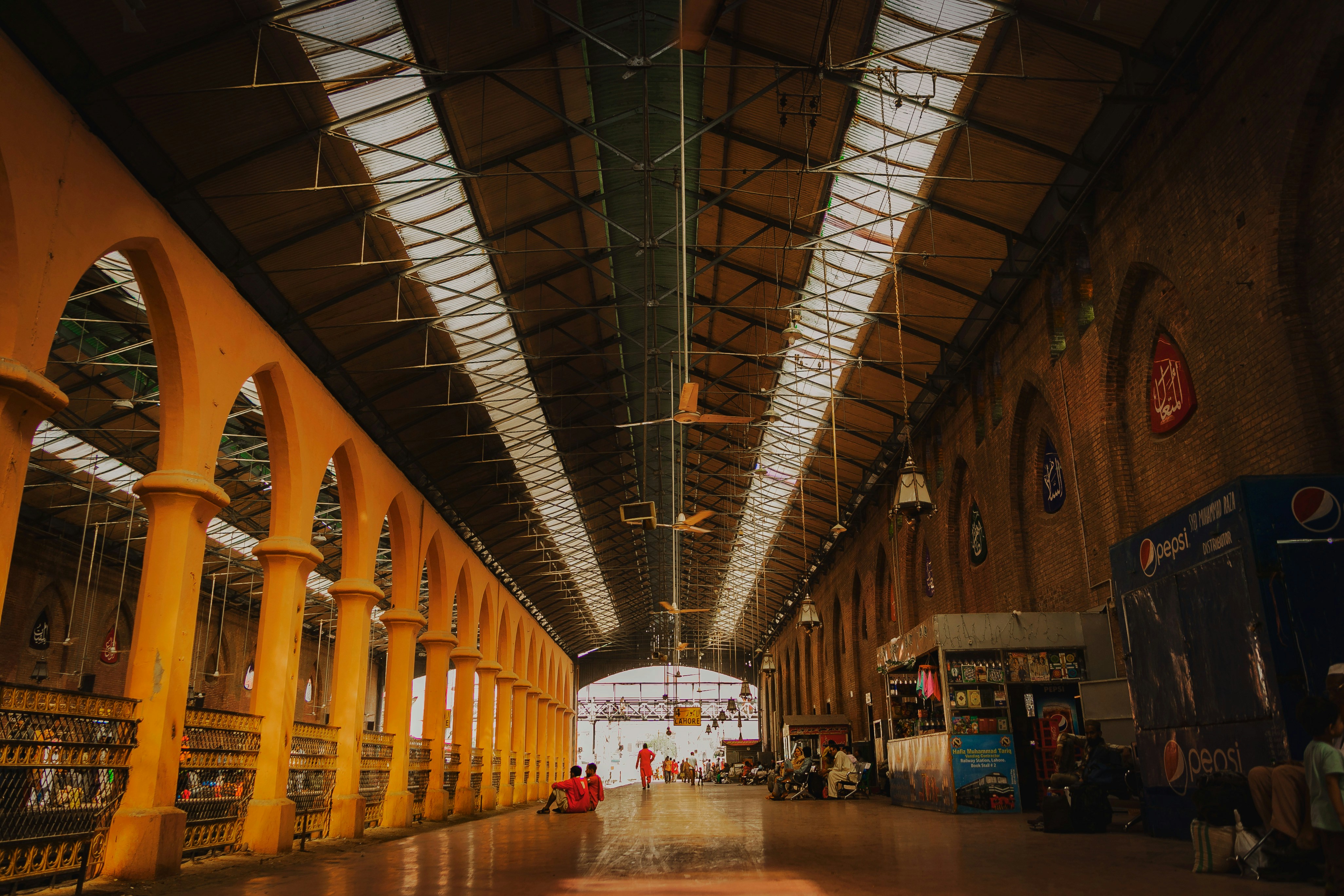 Vanishing Point Under Warm Arches: A Quiet Station Hall