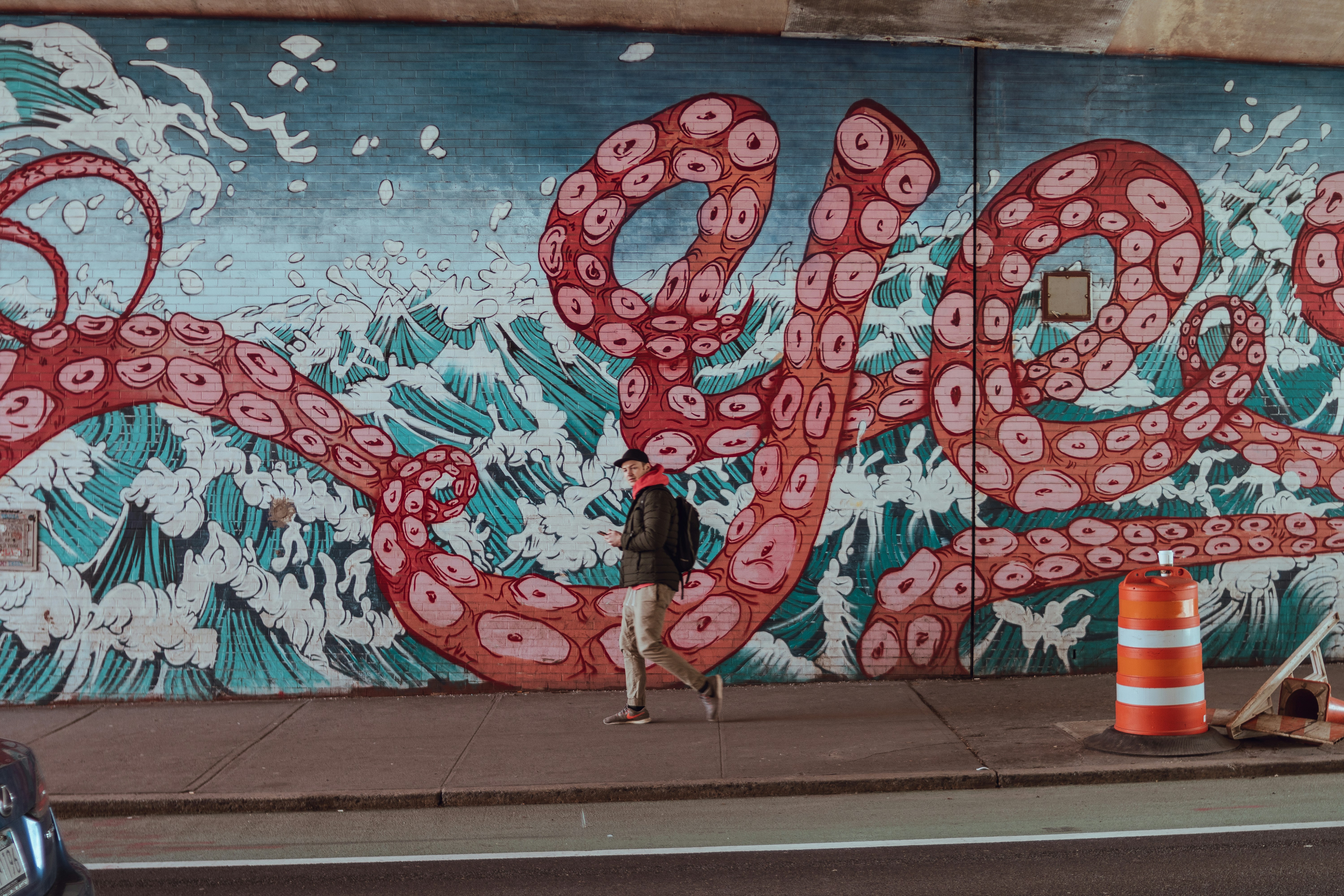 Stroll Under the Kraken: Pedestrian Amid a Sea-Tentacle Mural