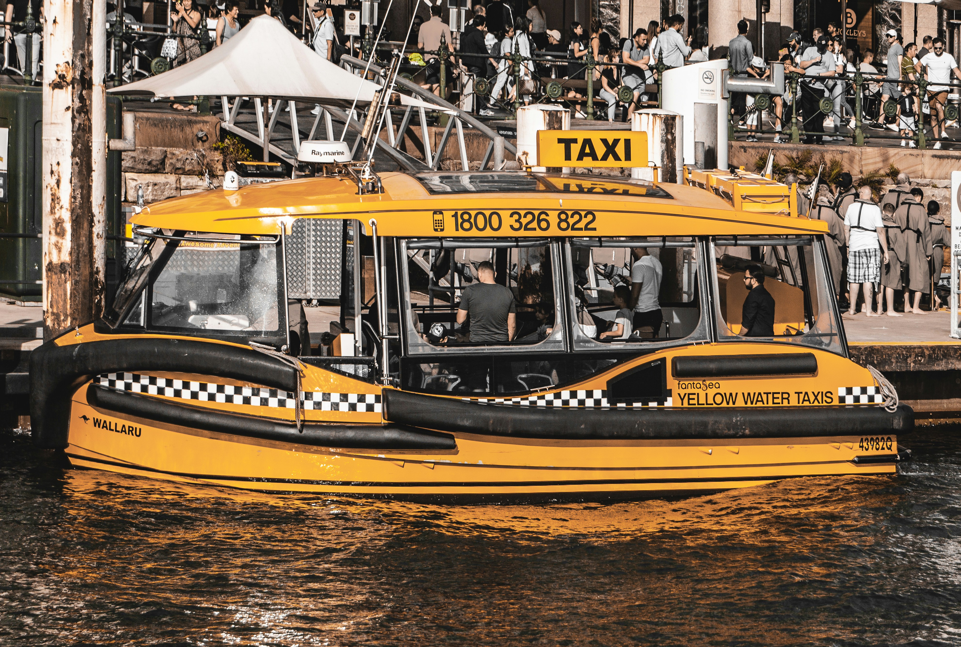 Harbor Yellow: Sunlit Water Taxi at the Dock
