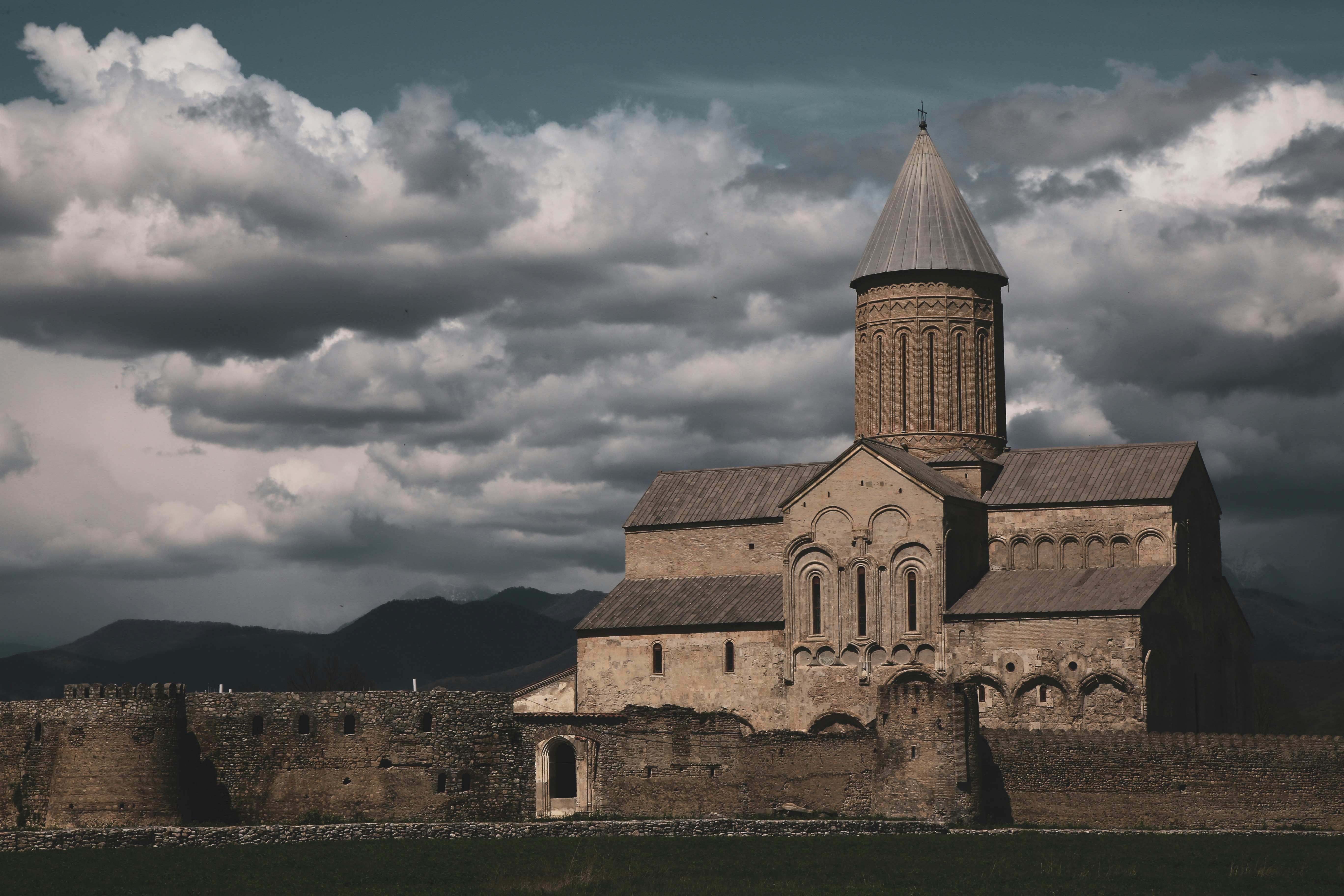 Stone Fortress: A Gothic Church Standing Against Tempest Clouds