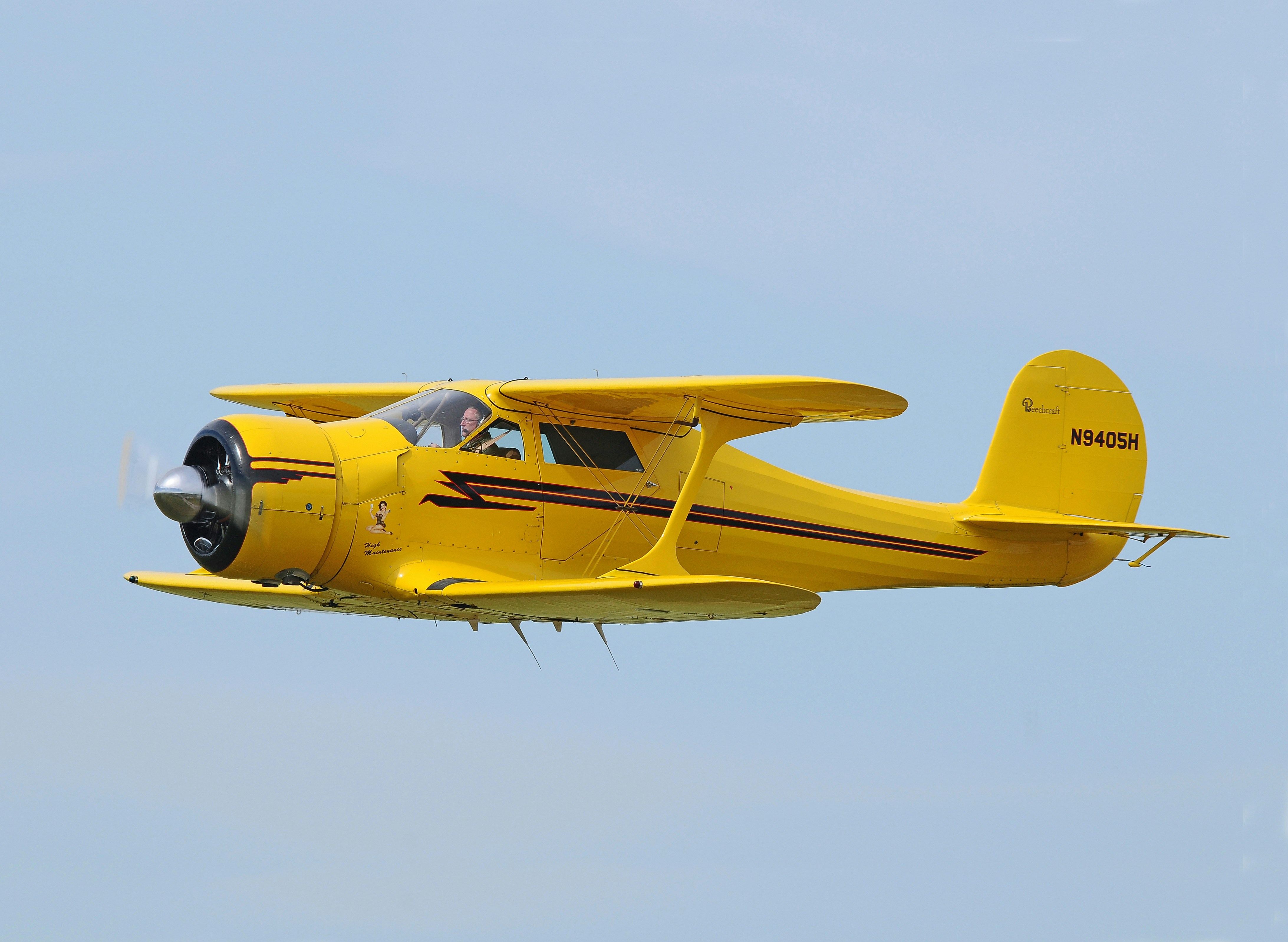 Selective focus photography of yellow biplane on air during daytime ...